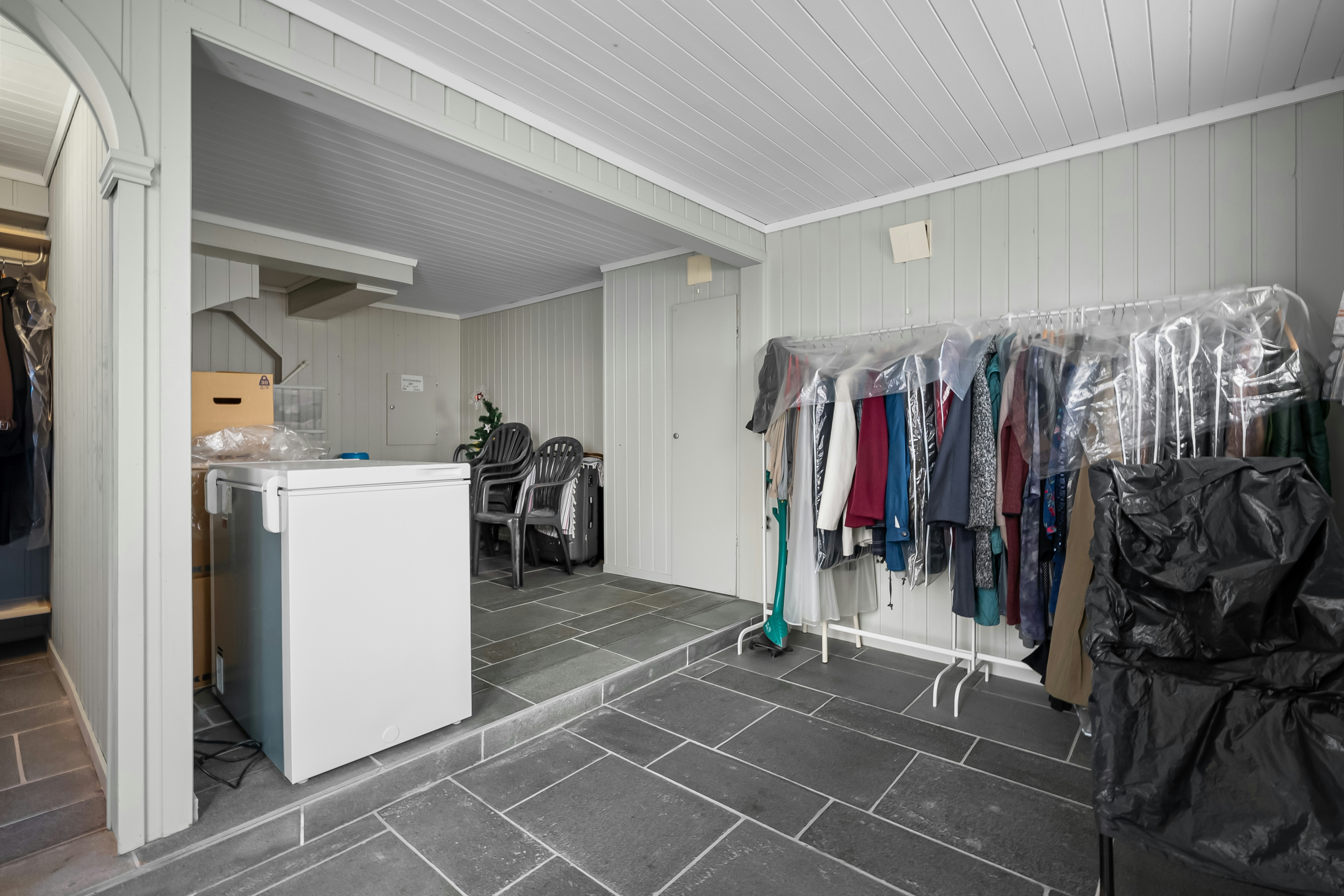 A room filled with lots of clothes and a refrigerator photo – Free ...