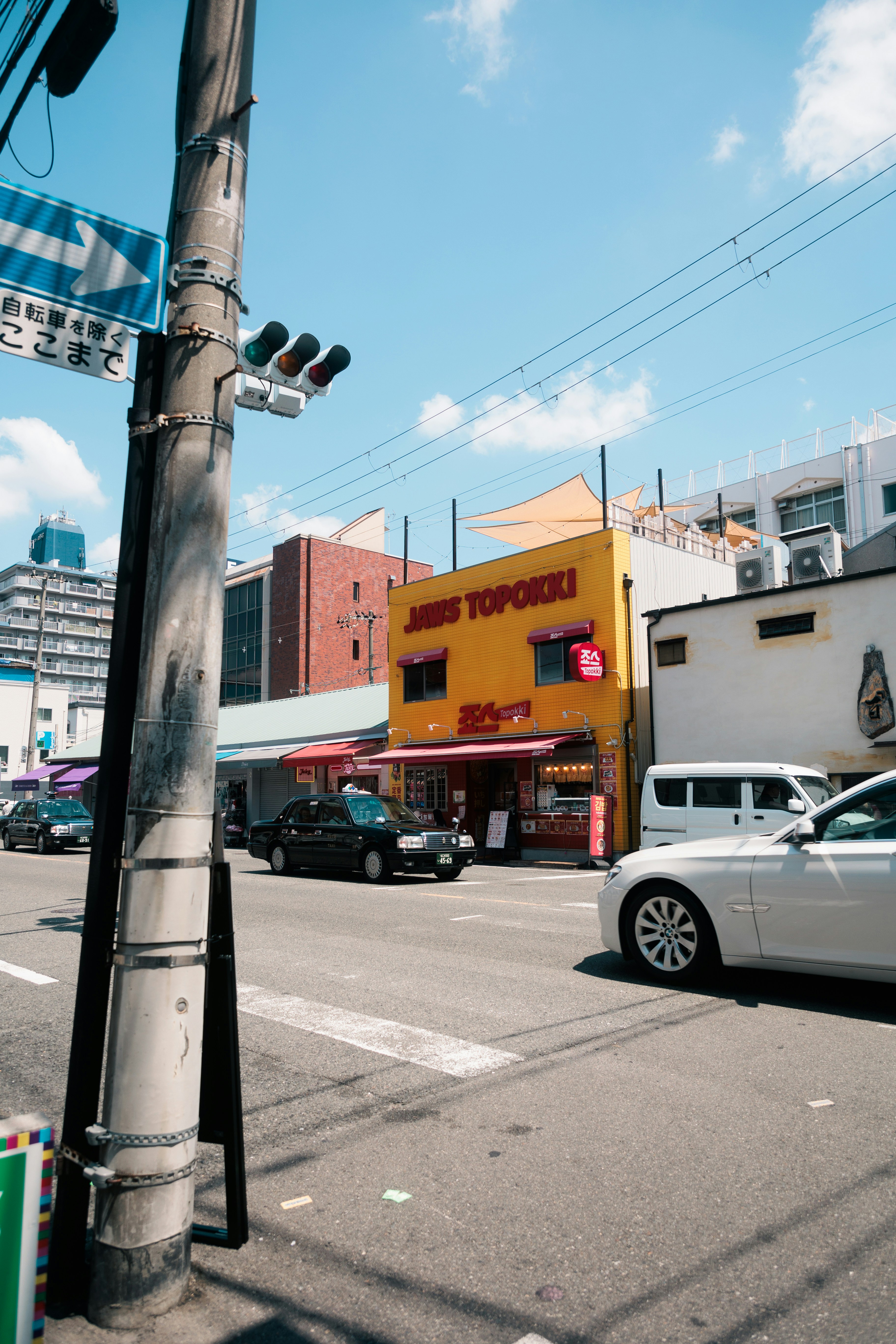 Jim's Topokki on a Sunlit City Block