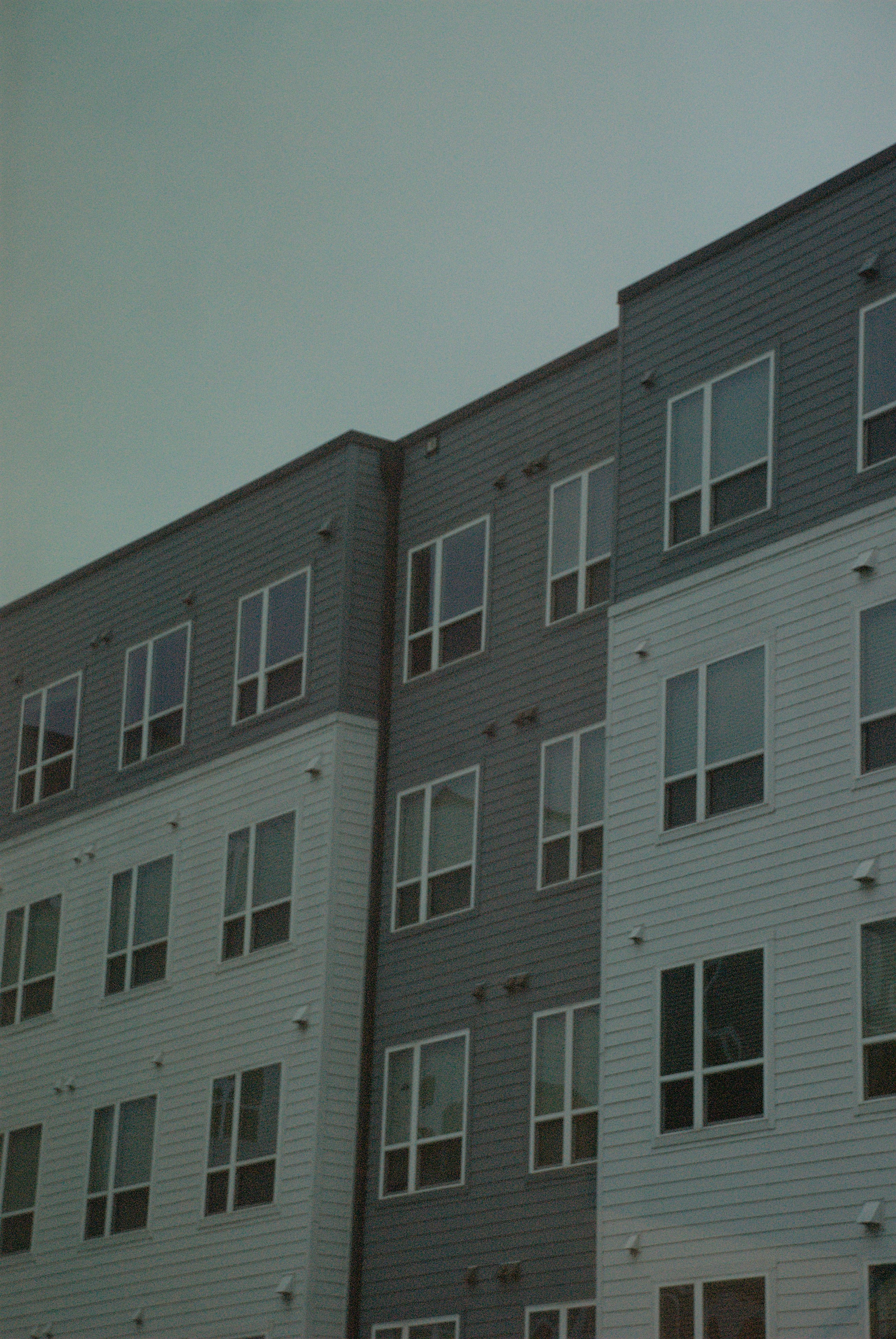 static-effect apartment building in shades of grey with cloudy sky