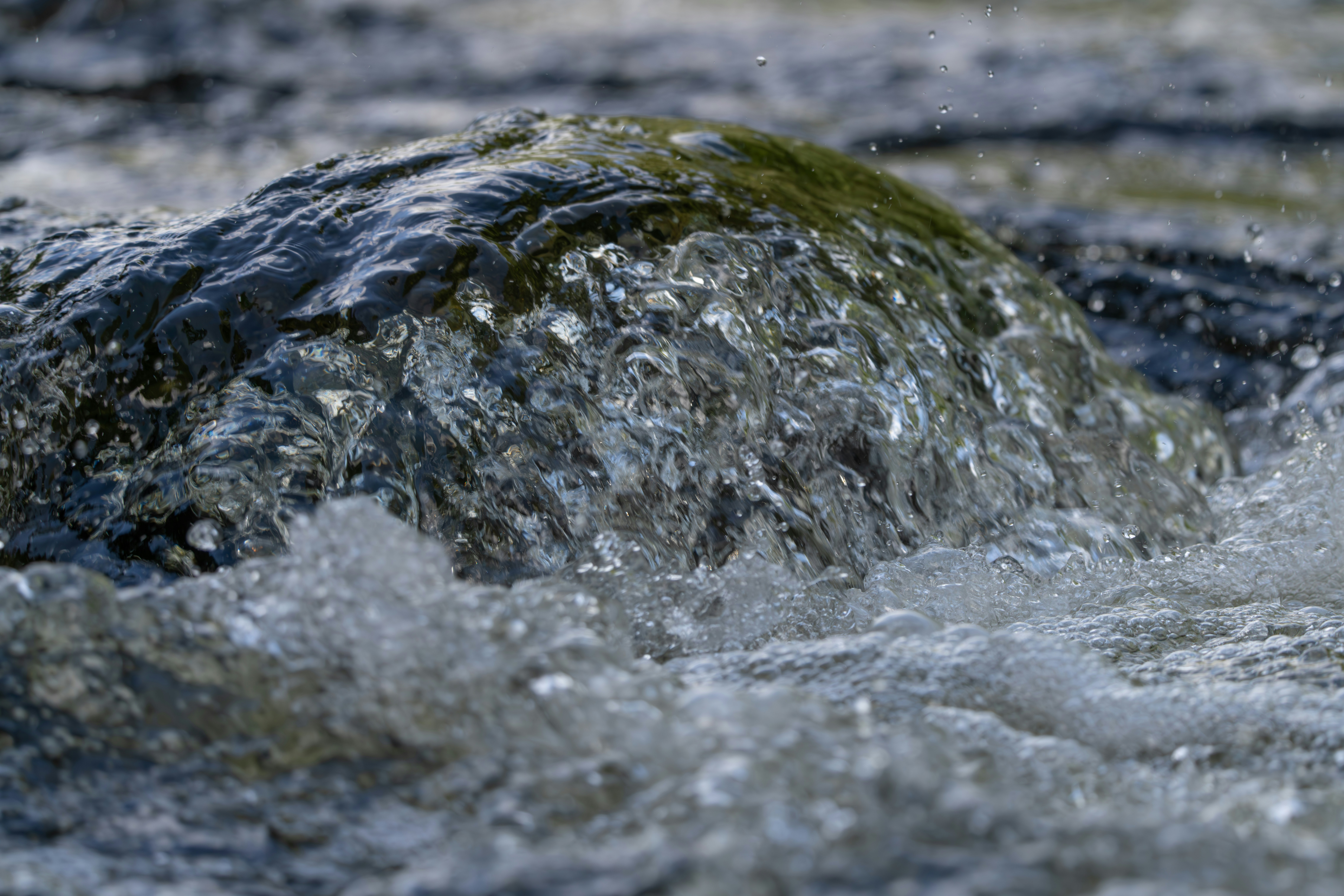 A close up of a rock in a body of water