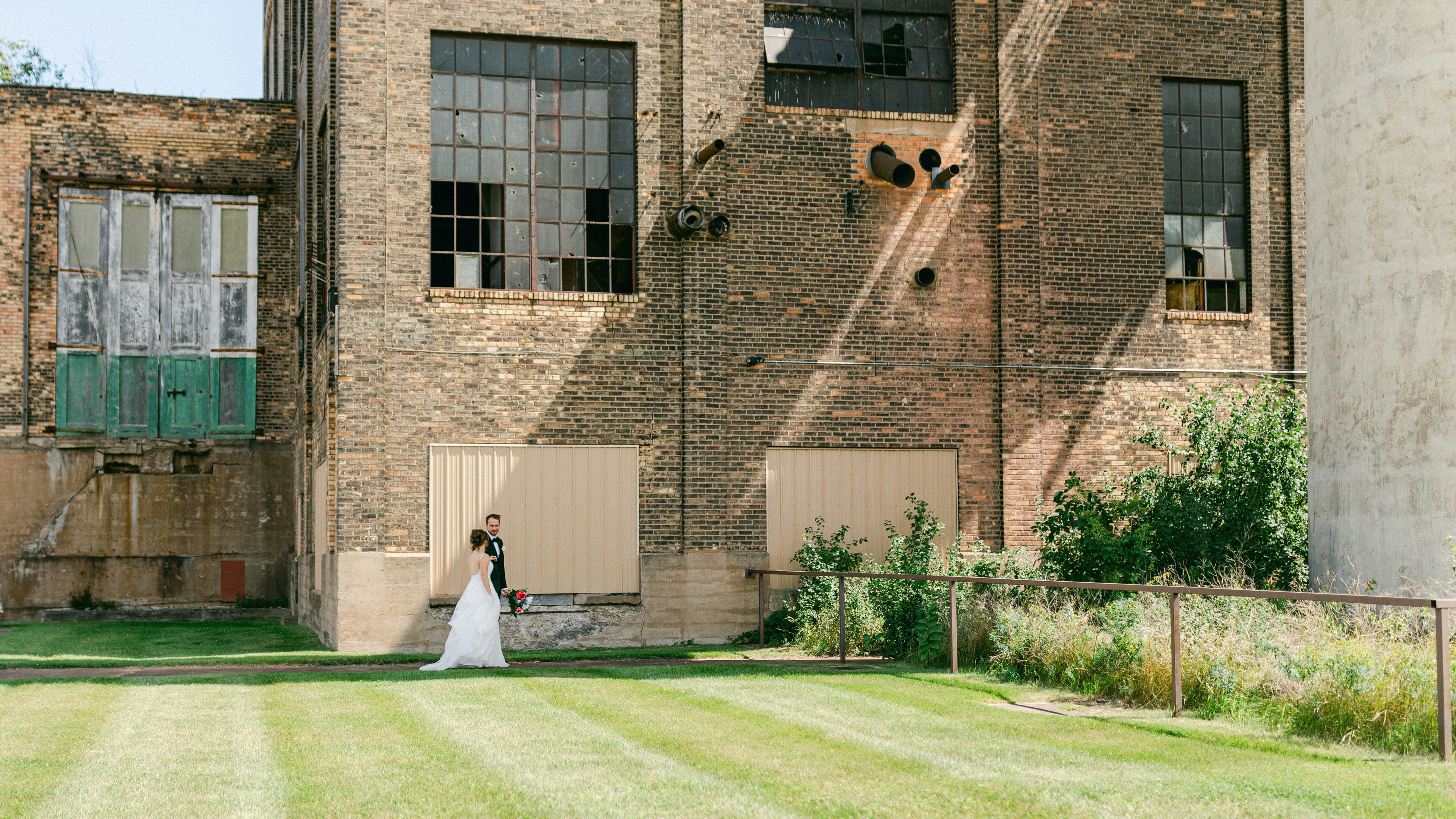 Brickwork and Lace: A Quiet Moment Between Bride and Groom