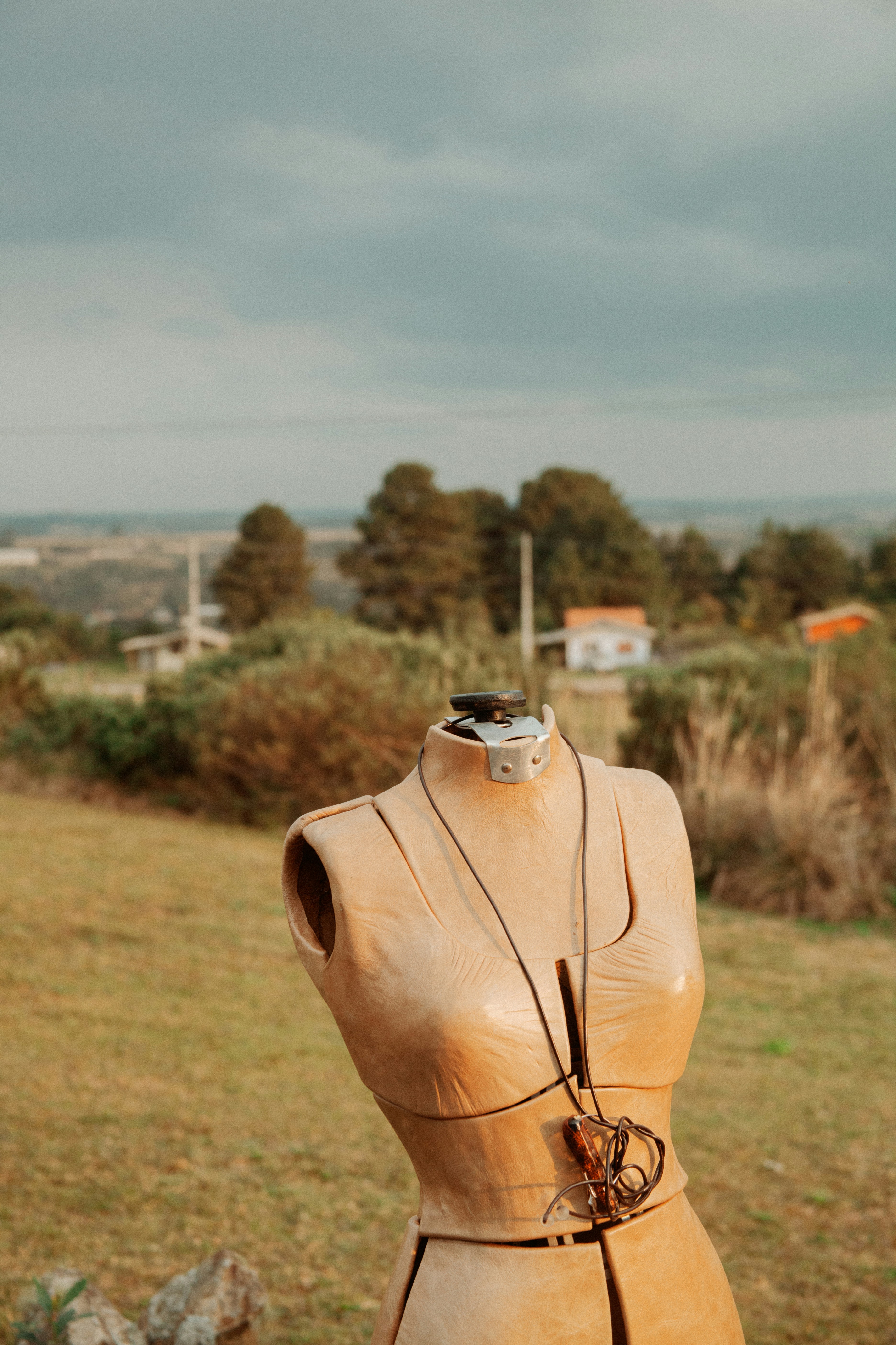 A Dressed Form in the Open Field: An Anthropomorphic Mannequin Stands Against a Rural Sunset