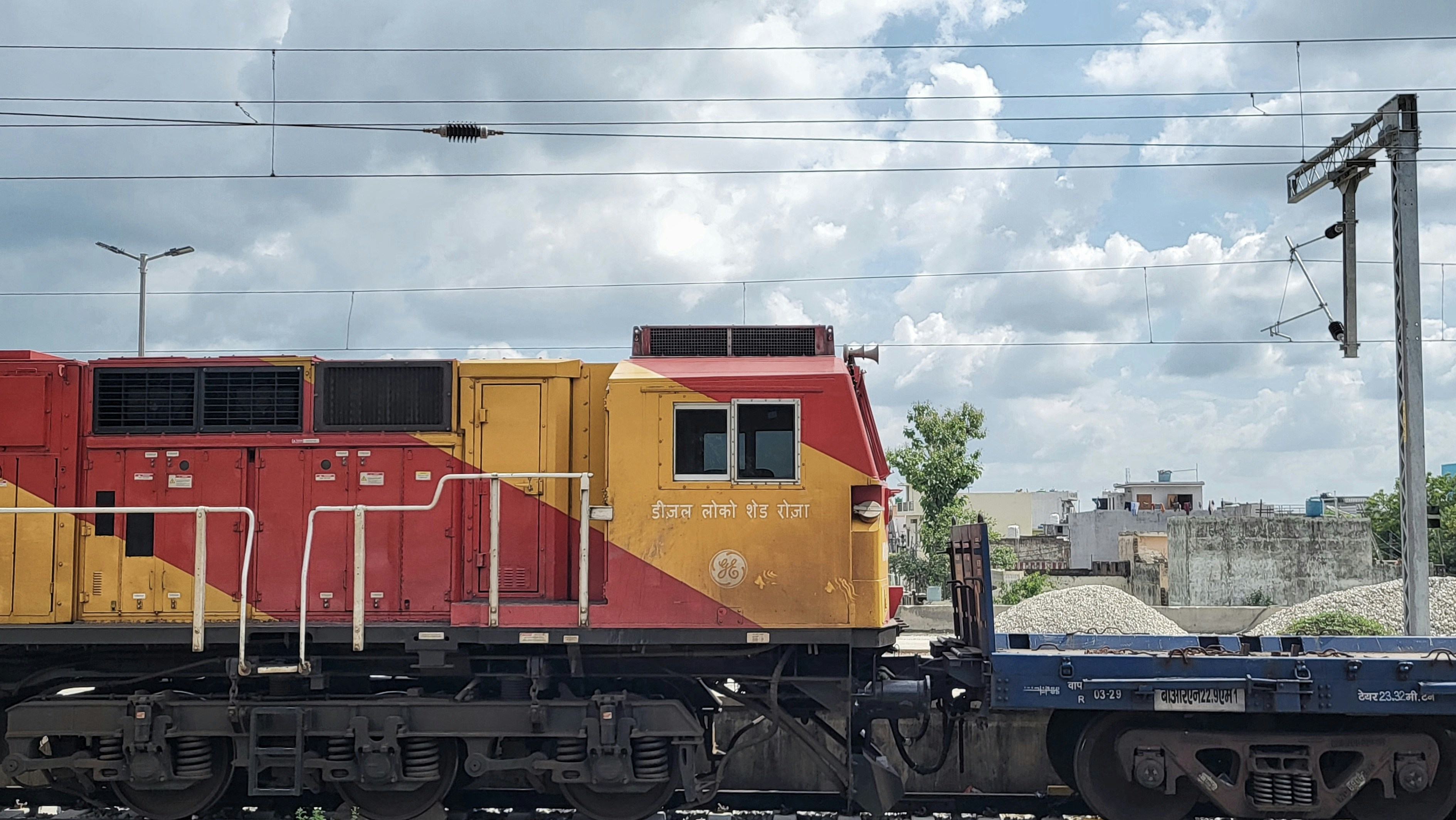 A red and yellow train traveling down train tracks photo – Free Train ...