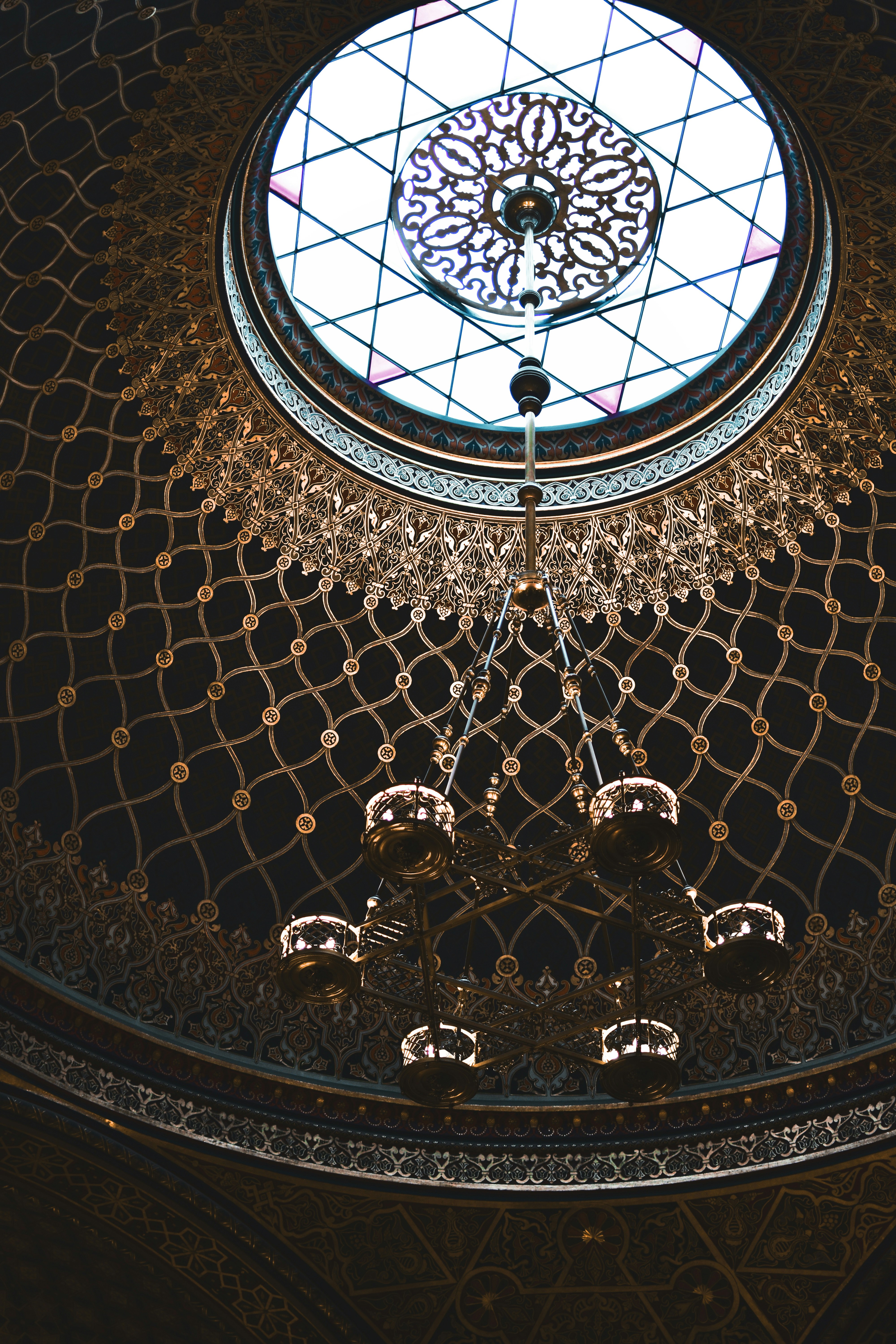 A circular glass window in the ceiling of a building photo – Free ...