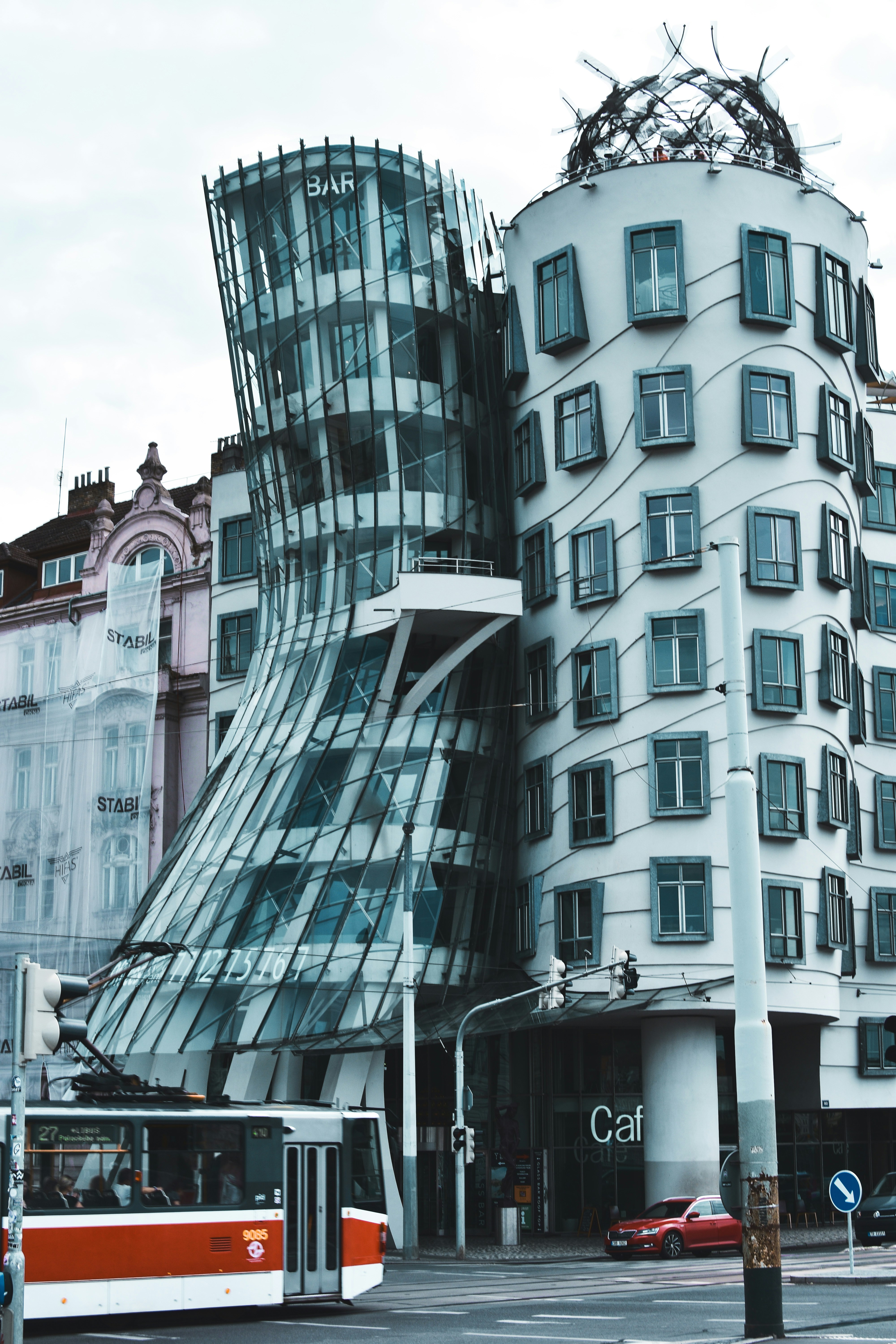 Prague's Dancing House: Glass Curves Beside a Round-Windowed Tower
