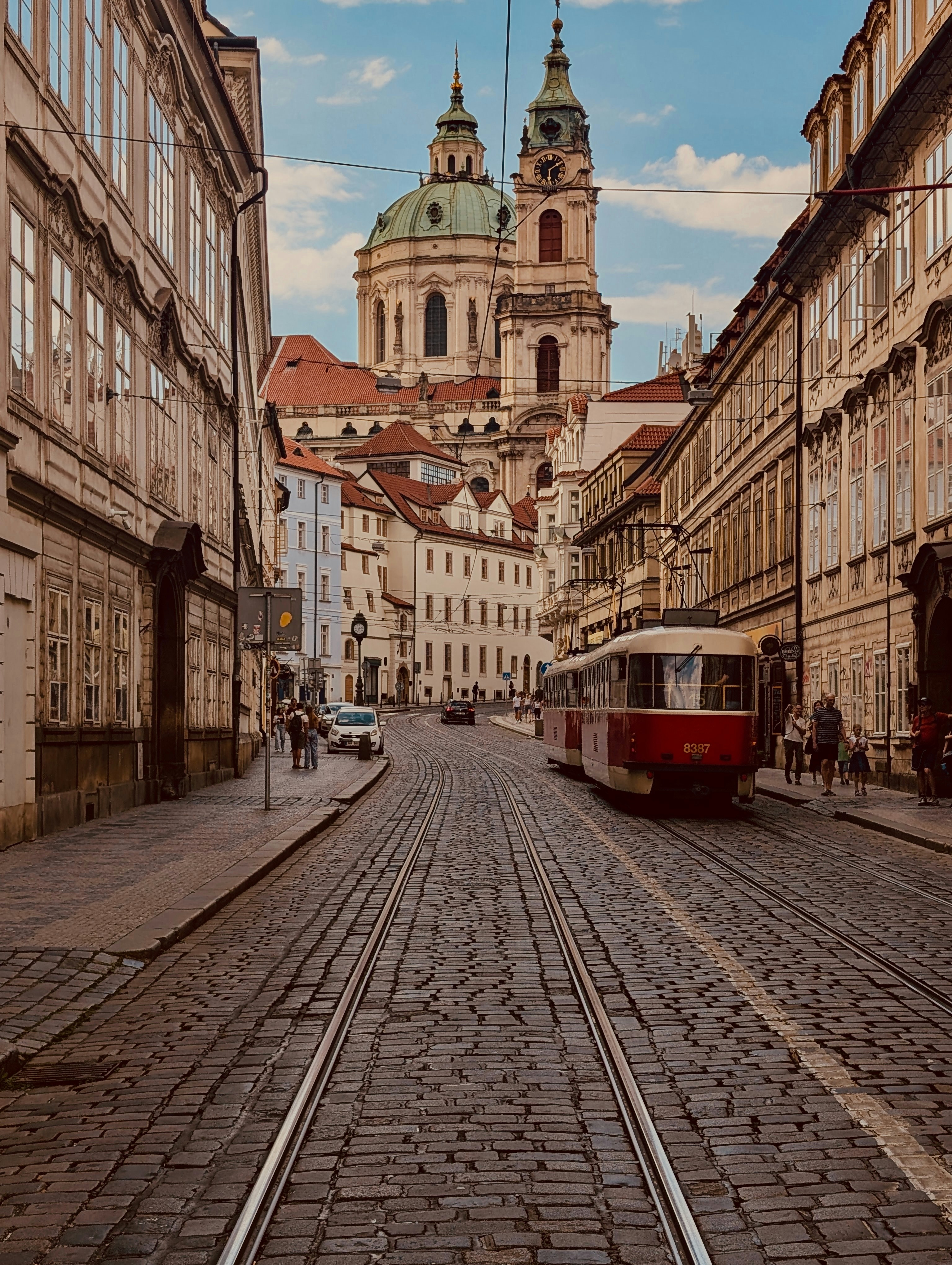 Tram Route Through a Historic Czech Street Toward a Baroque Cathedral