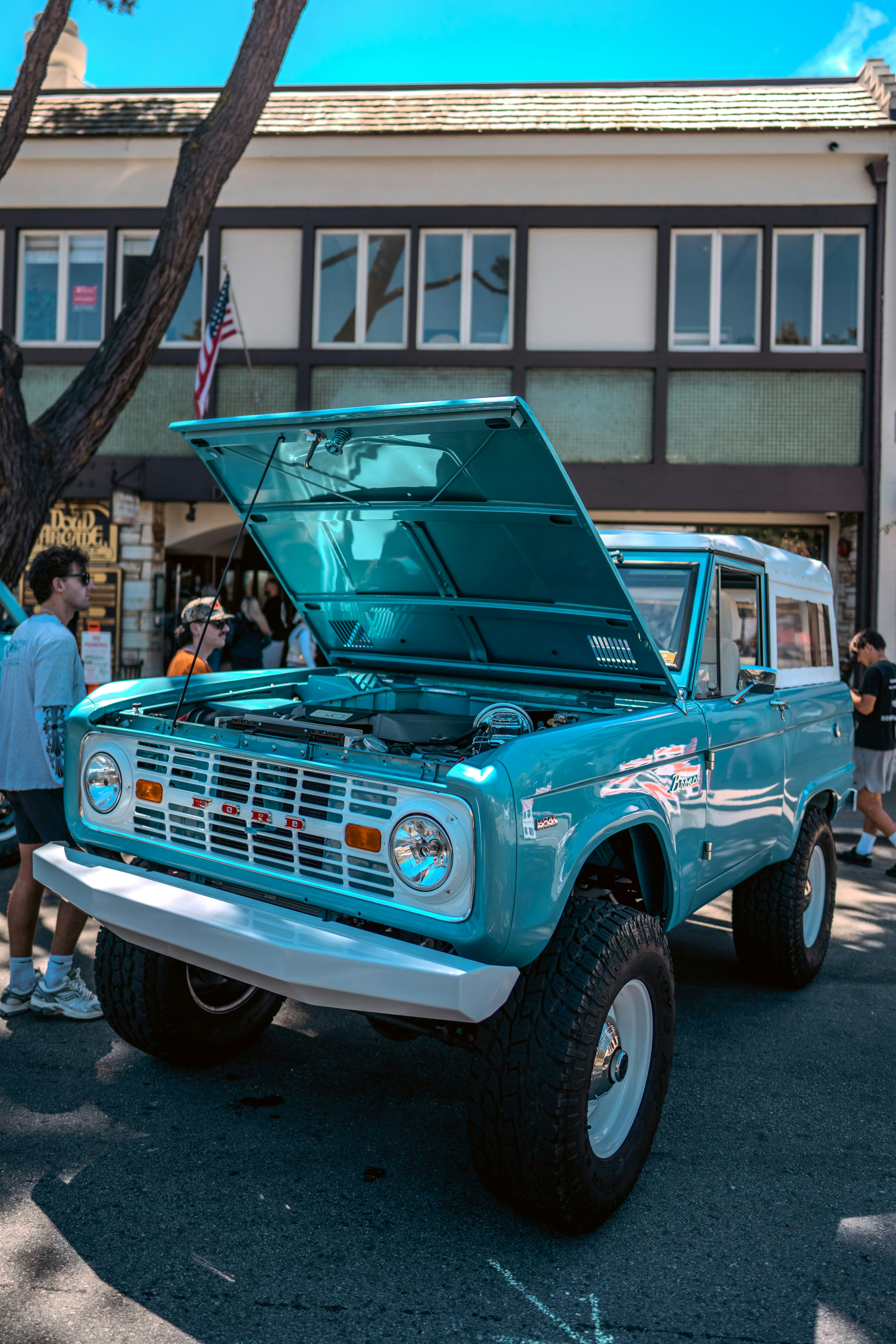 Hood-Up Turquoise Ford Pickup Steals the Spotlight at a Sunny Street Car Show