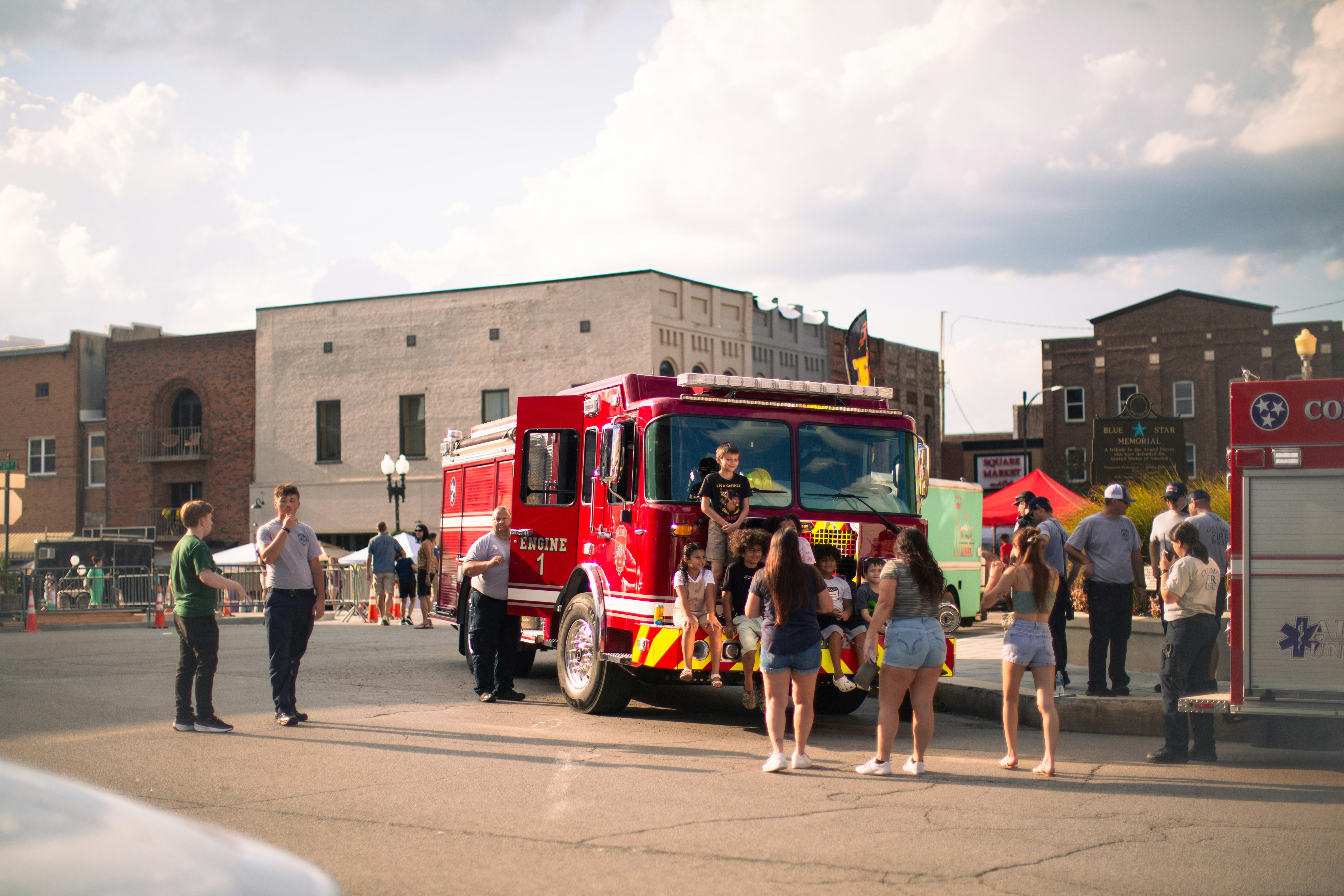 A group of people standing in front of a fire truck photo – Free Human ...