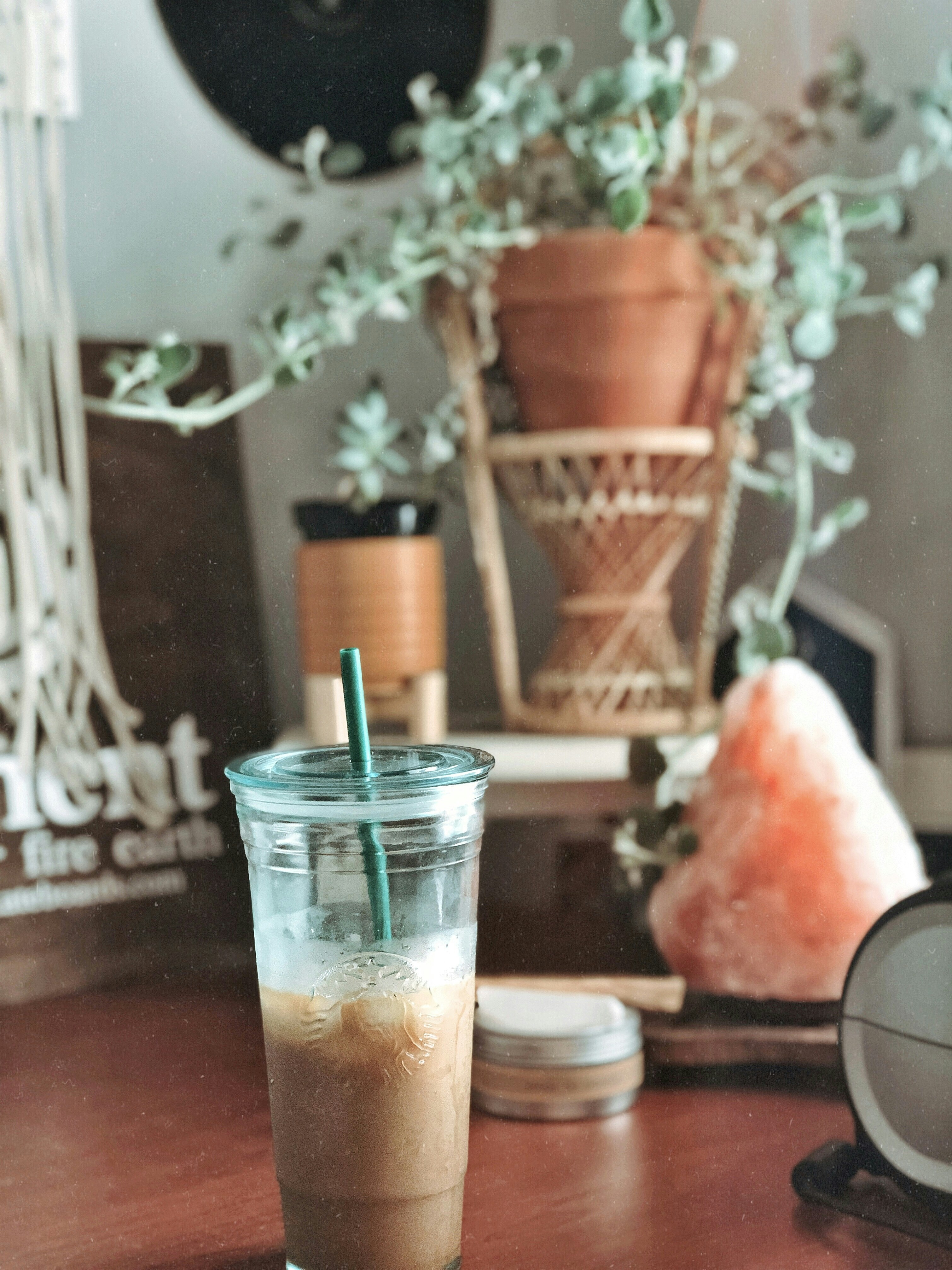 Glass and Greens: A Cozy Desk Still Life with Iced Coffee