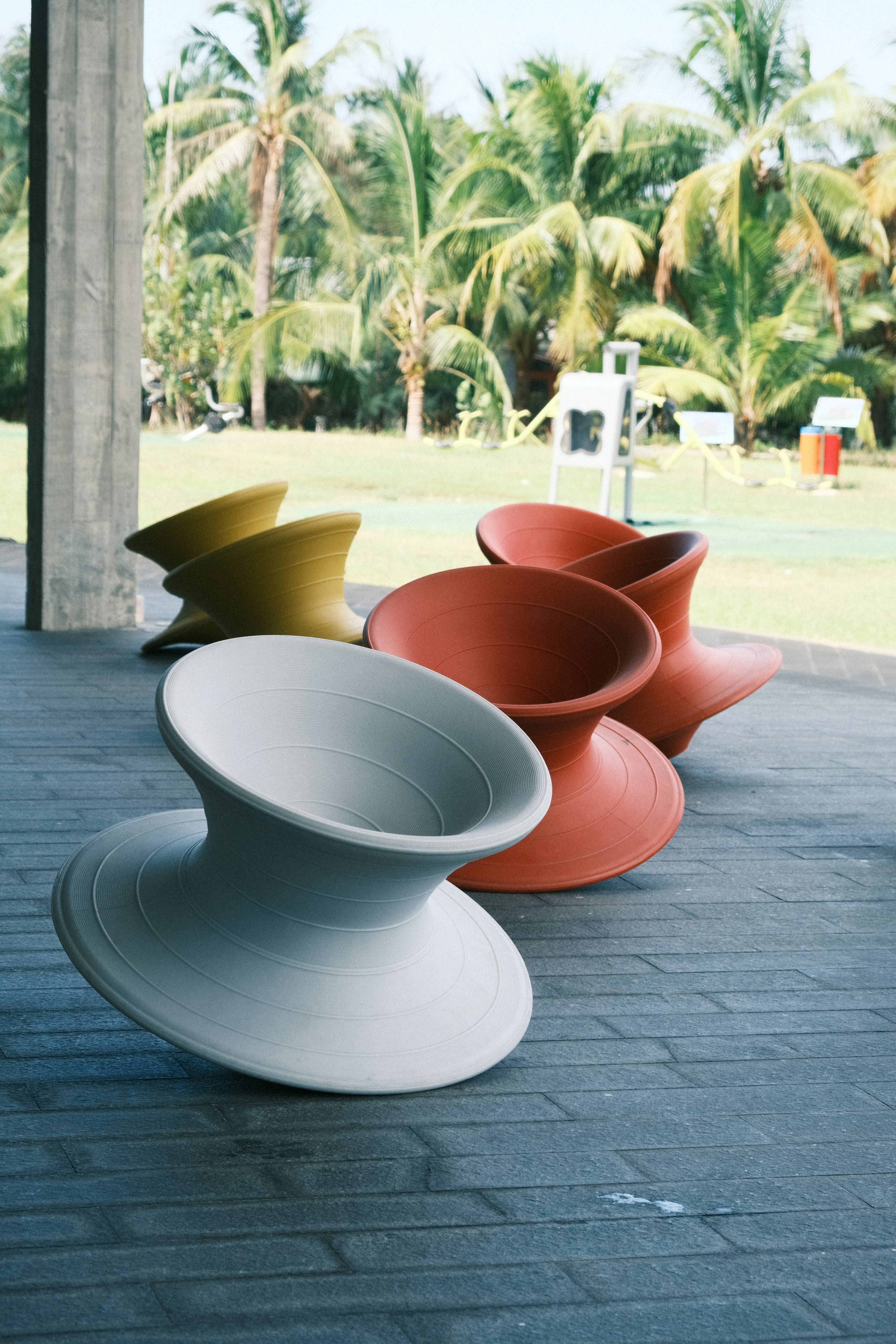 Palette of Spinning Loungers on a Palm-Shaded Terrace