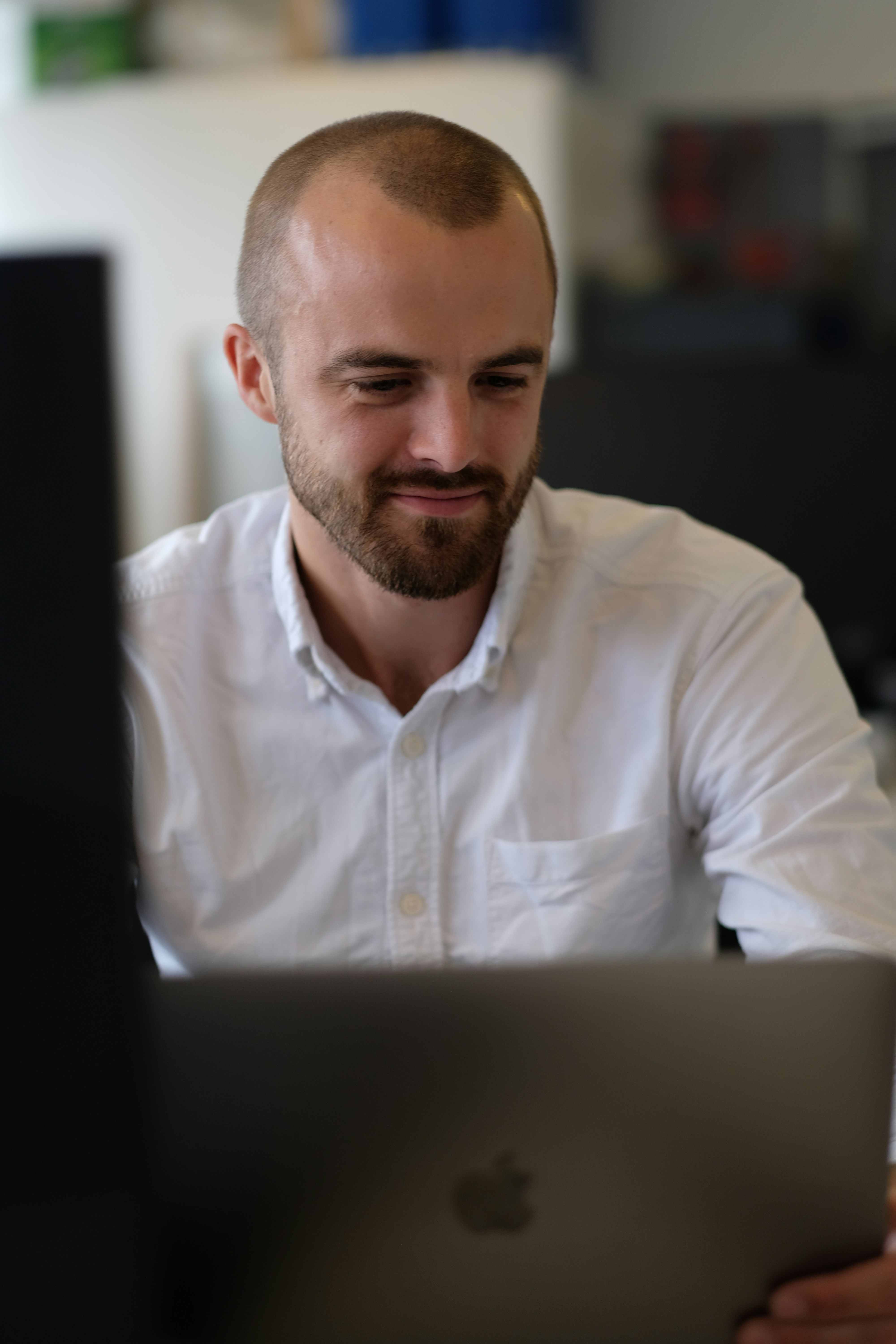 A man sitting in front of a laptop computer photo – Free Portrait Image ...