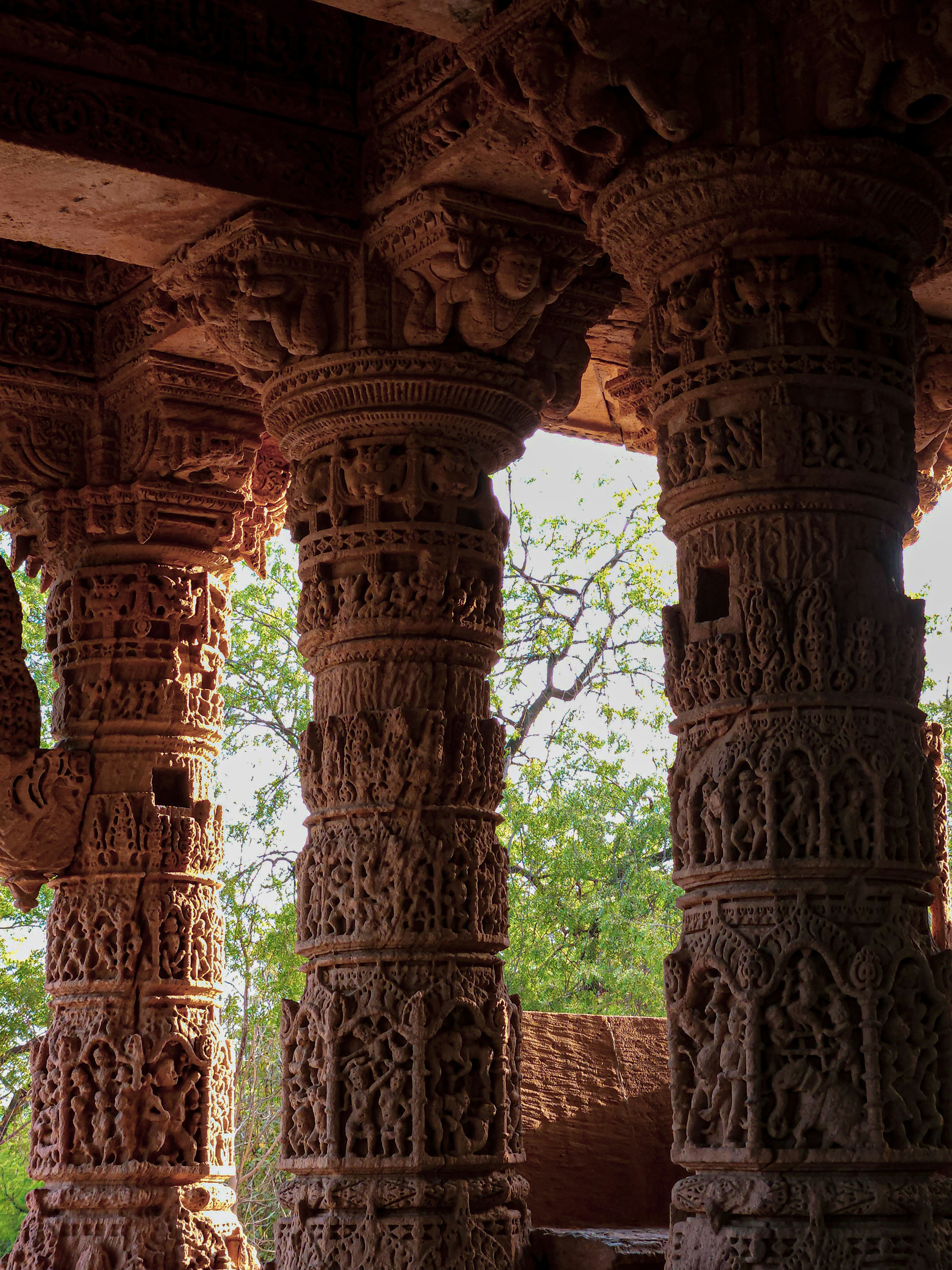 A group of pillars that have carvings on them photo – Free Gujarat ...