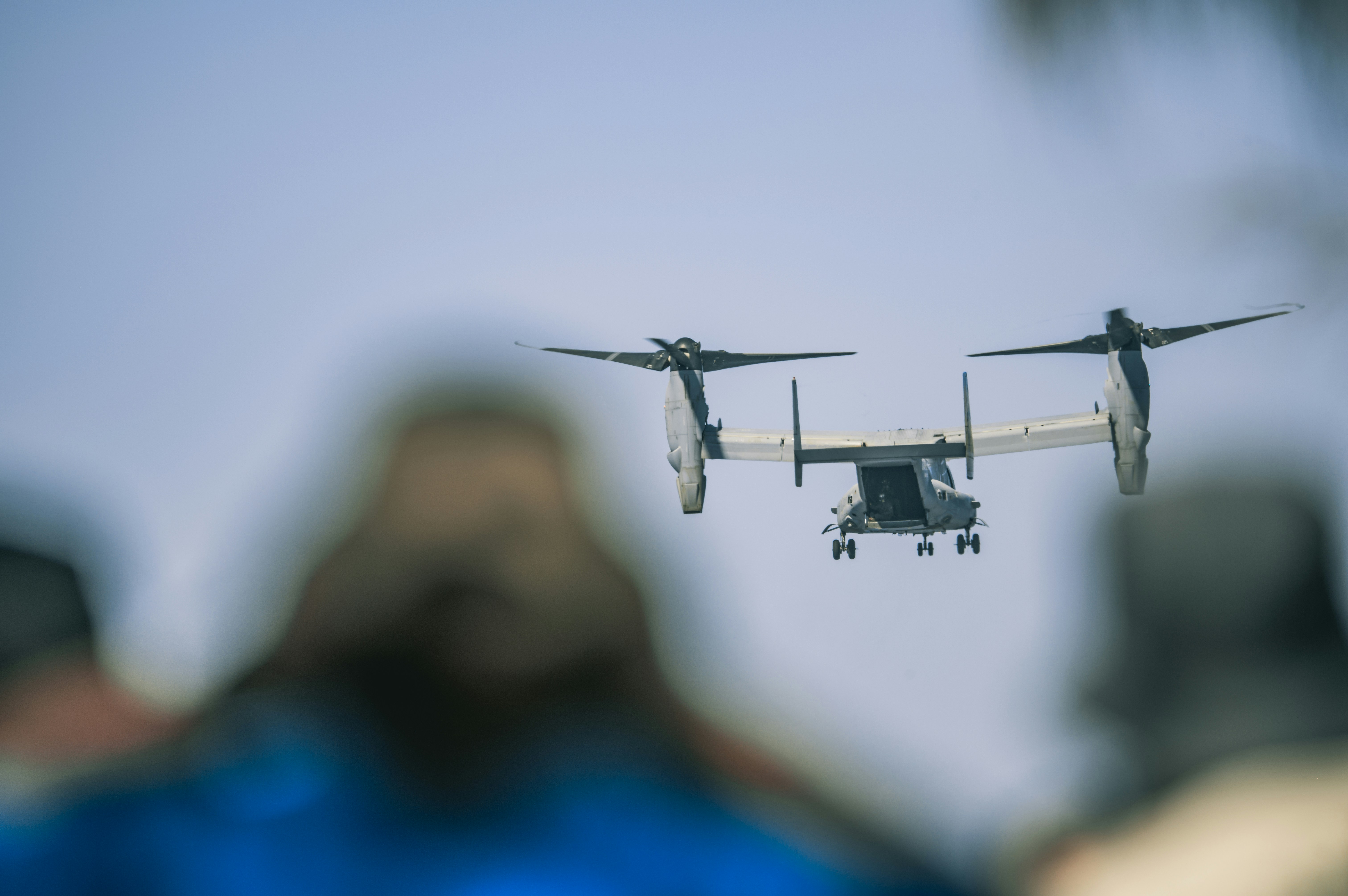 A small airplane flying over a crowd of people photo – Free Surfers ...