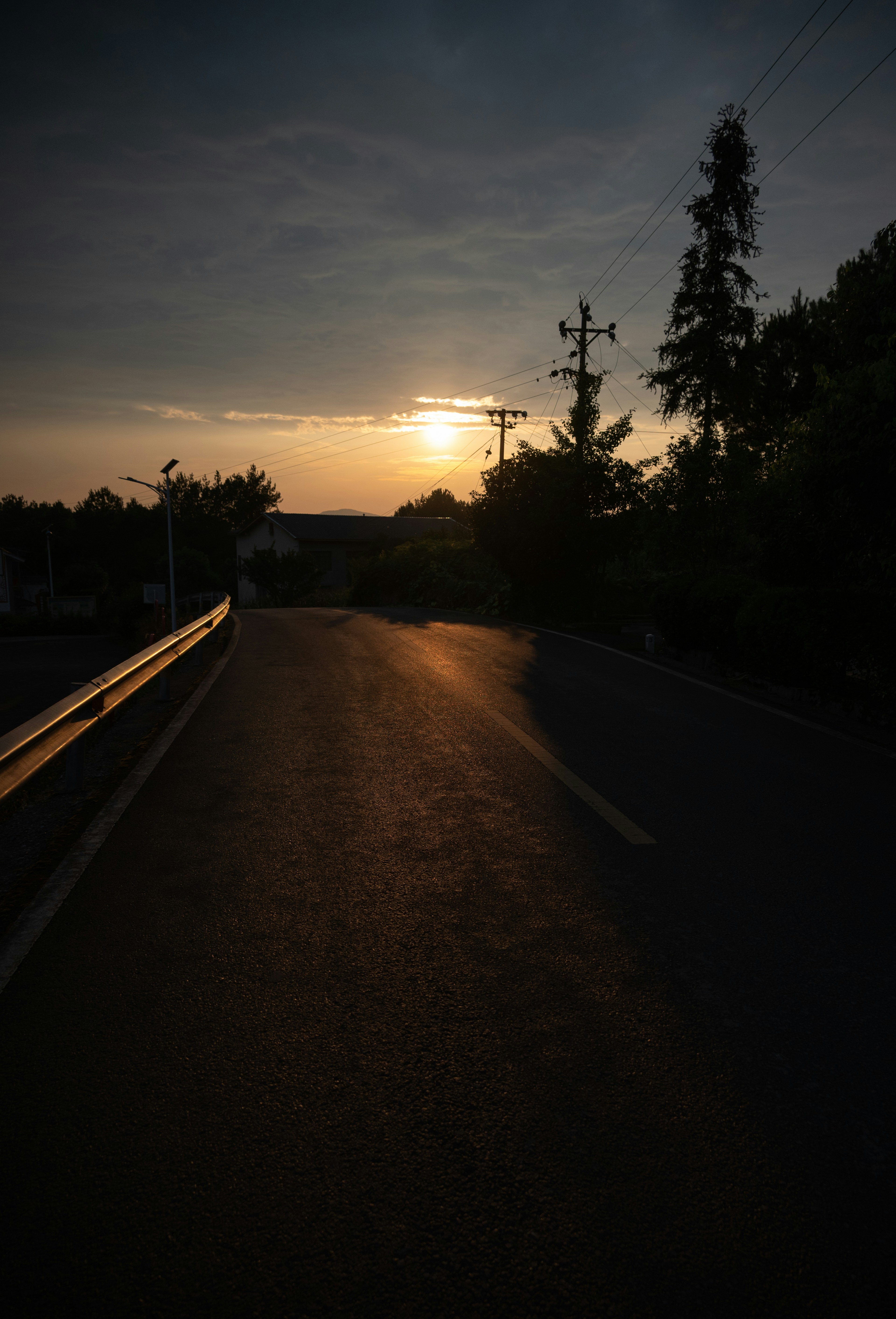 Guard Rail Glow: Sunset Quiet on a Winding Road