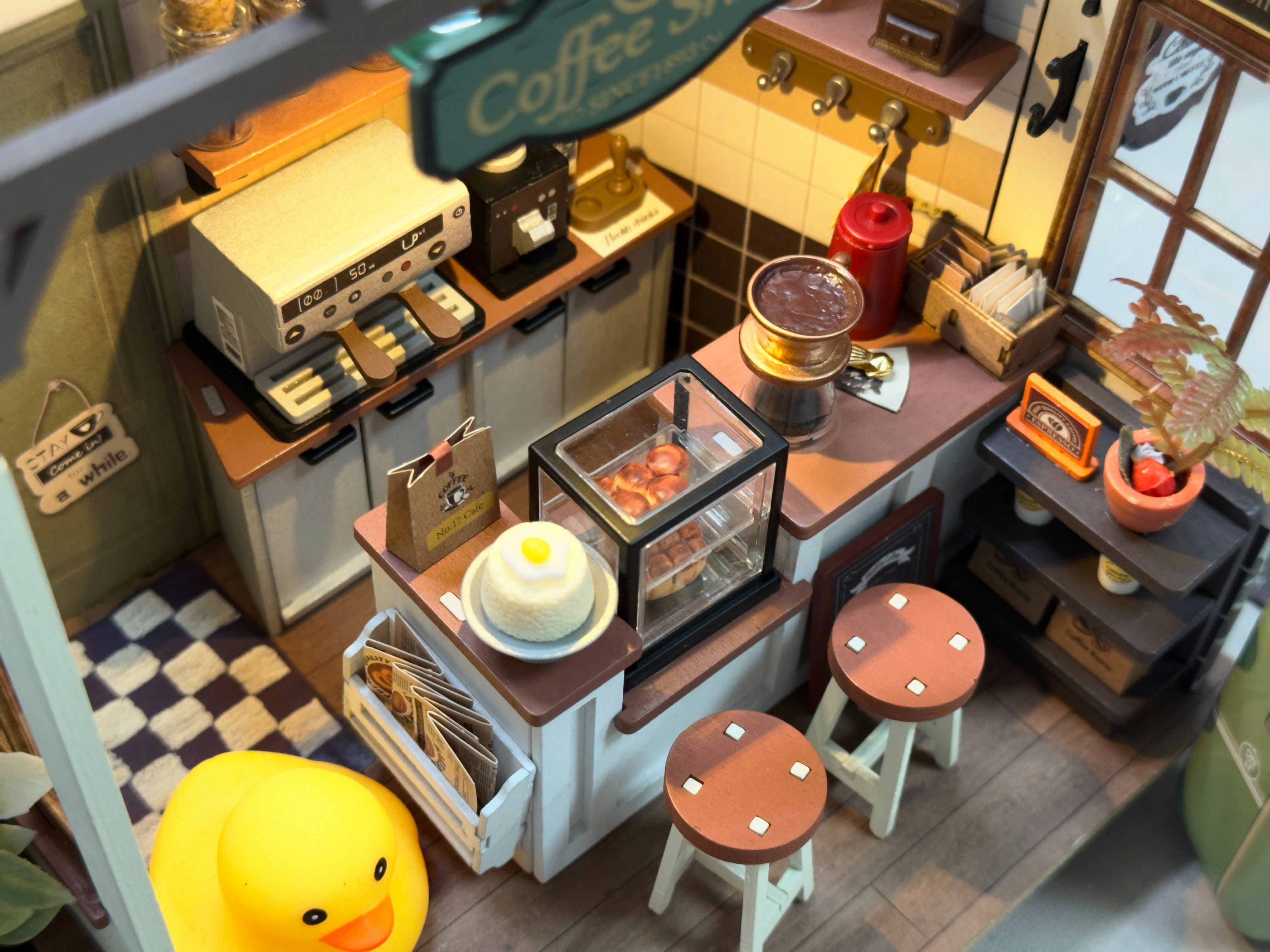 Tilted Mini Café: A Cozy Pastry Display in a Toy Kitchen