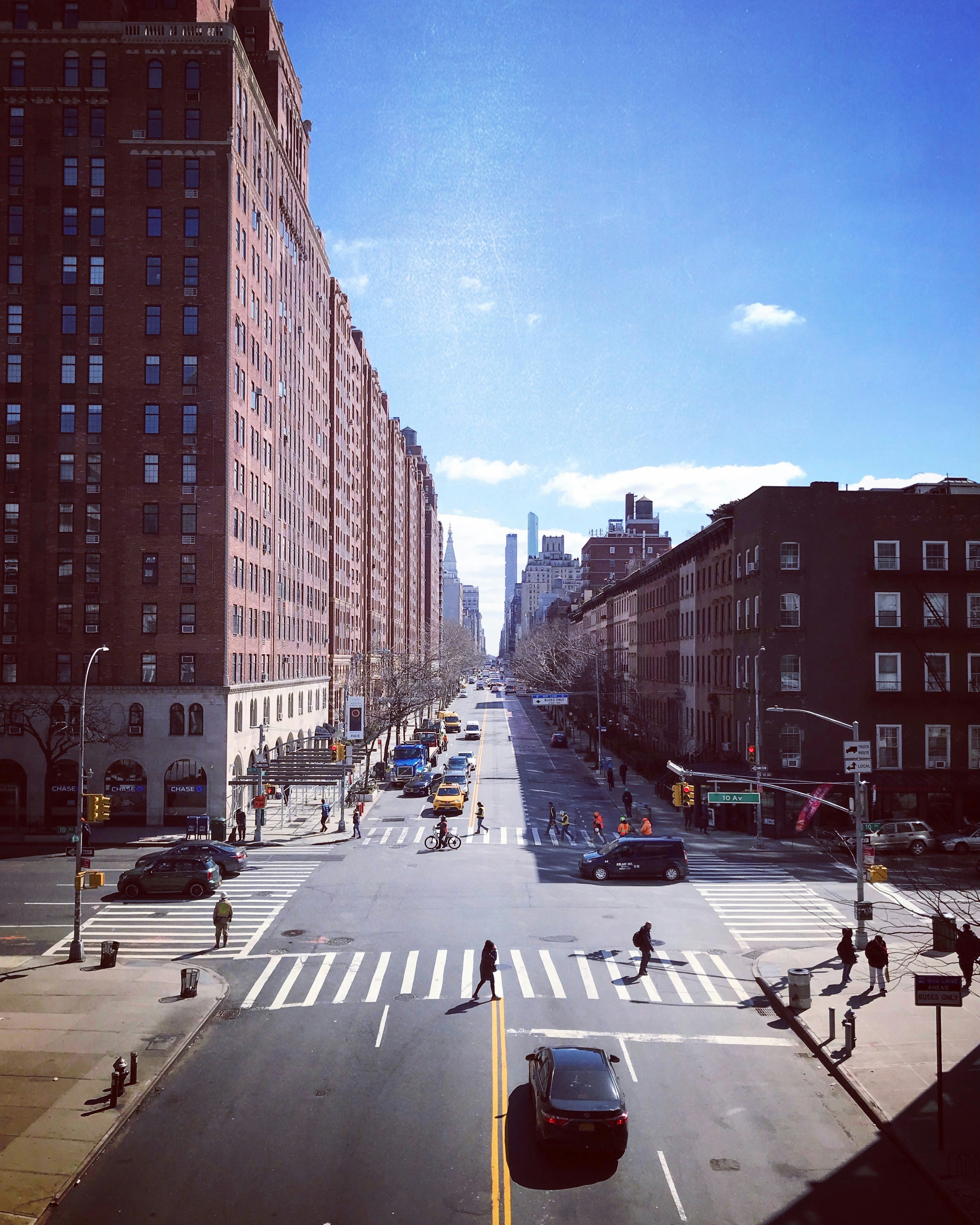 A city street filled with lots of tall buildings photo – Free Car Image ...