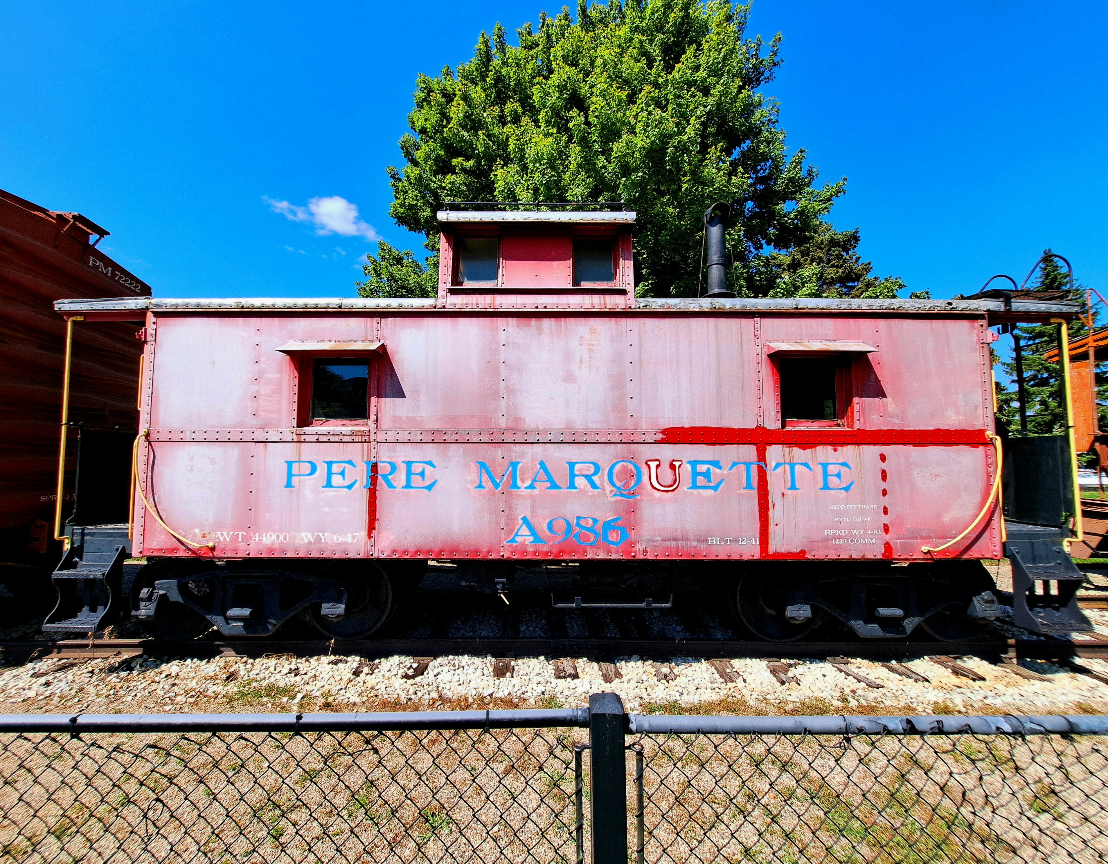 A red train car sitting on top of train tracks photo – Free Train Image ...