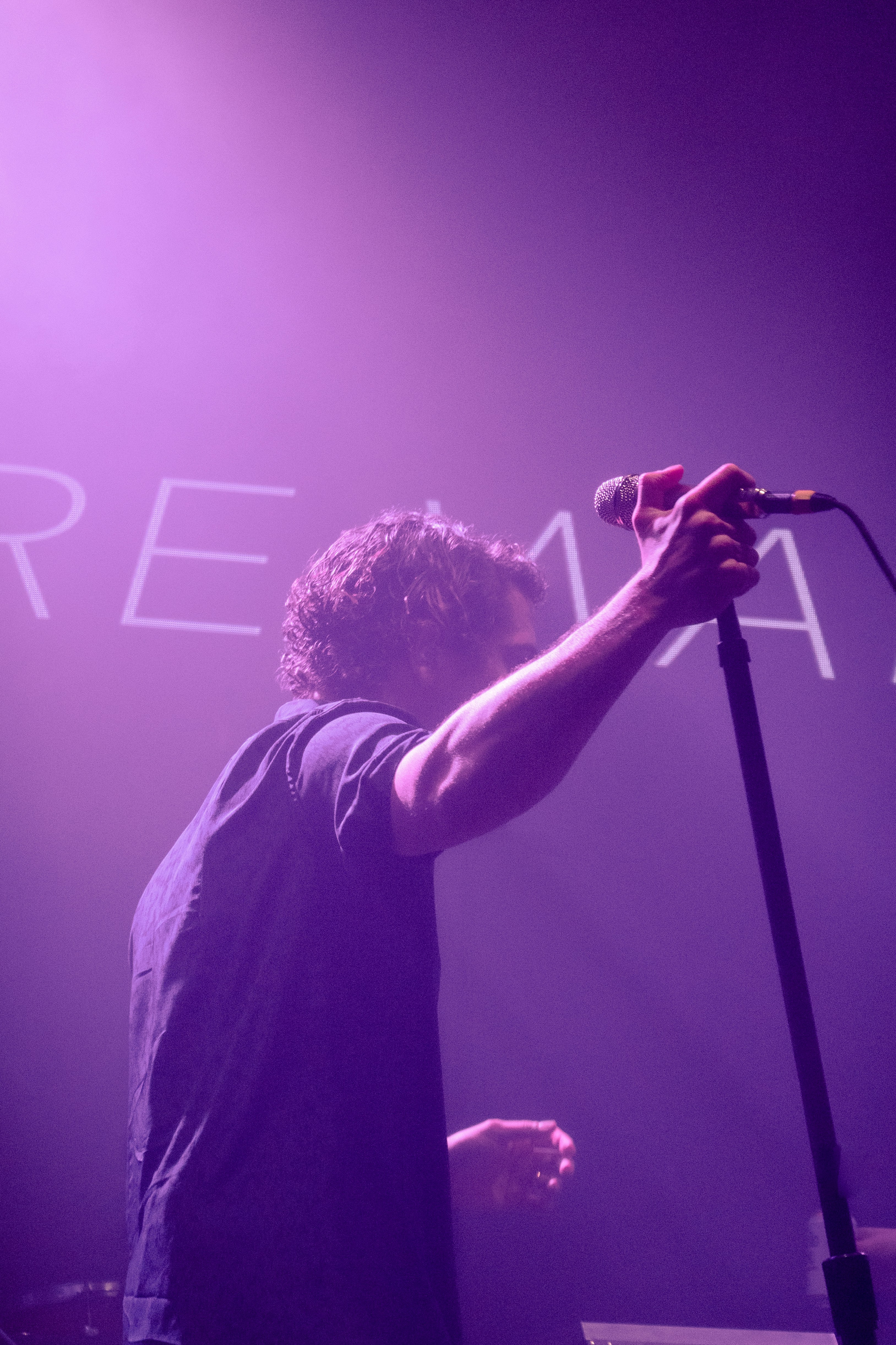 Violet Spotlight: Grasping the Mic in a Purple Fog