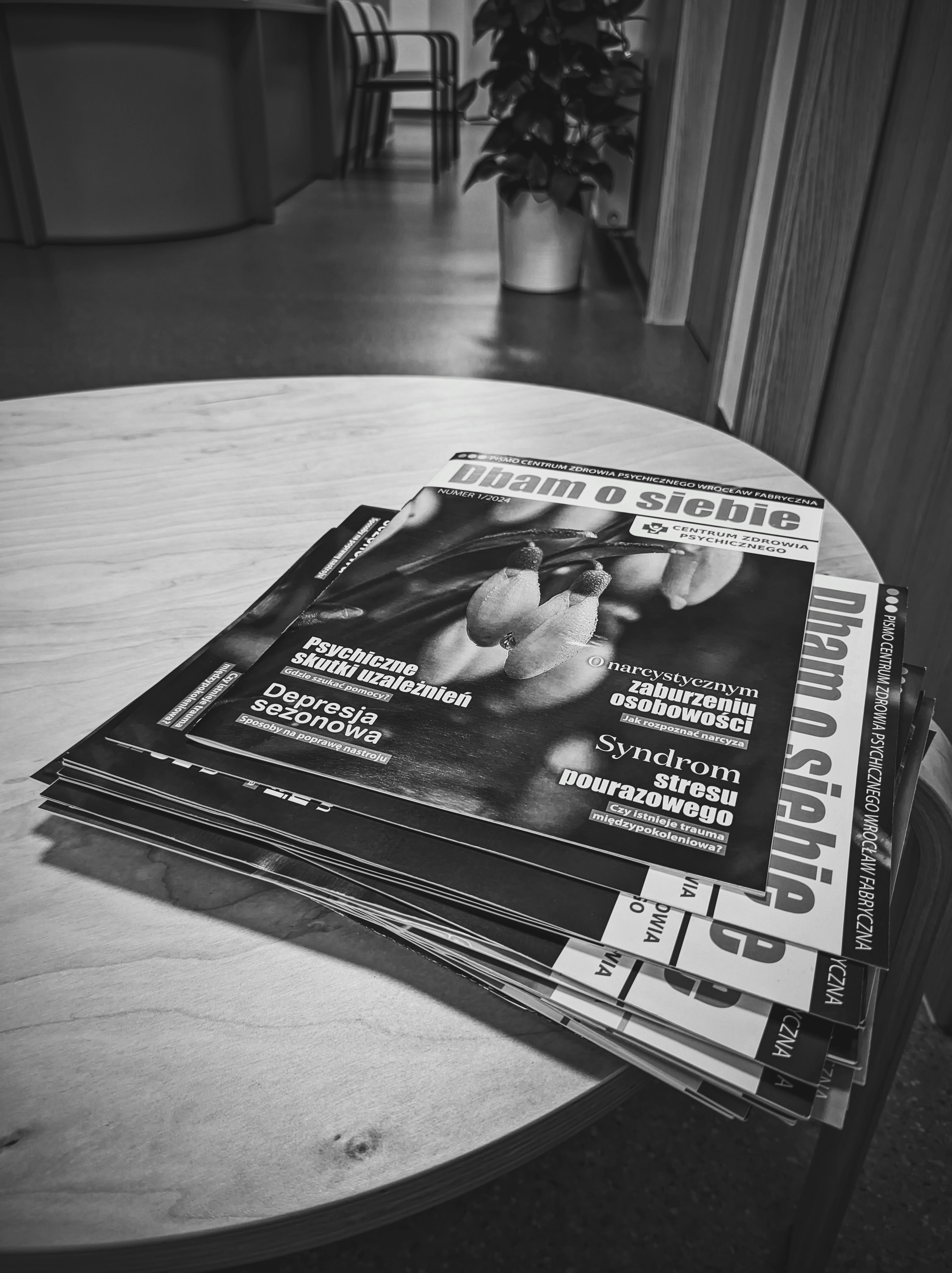 Magazine Stack on a Wooden Table in a Quiet Café