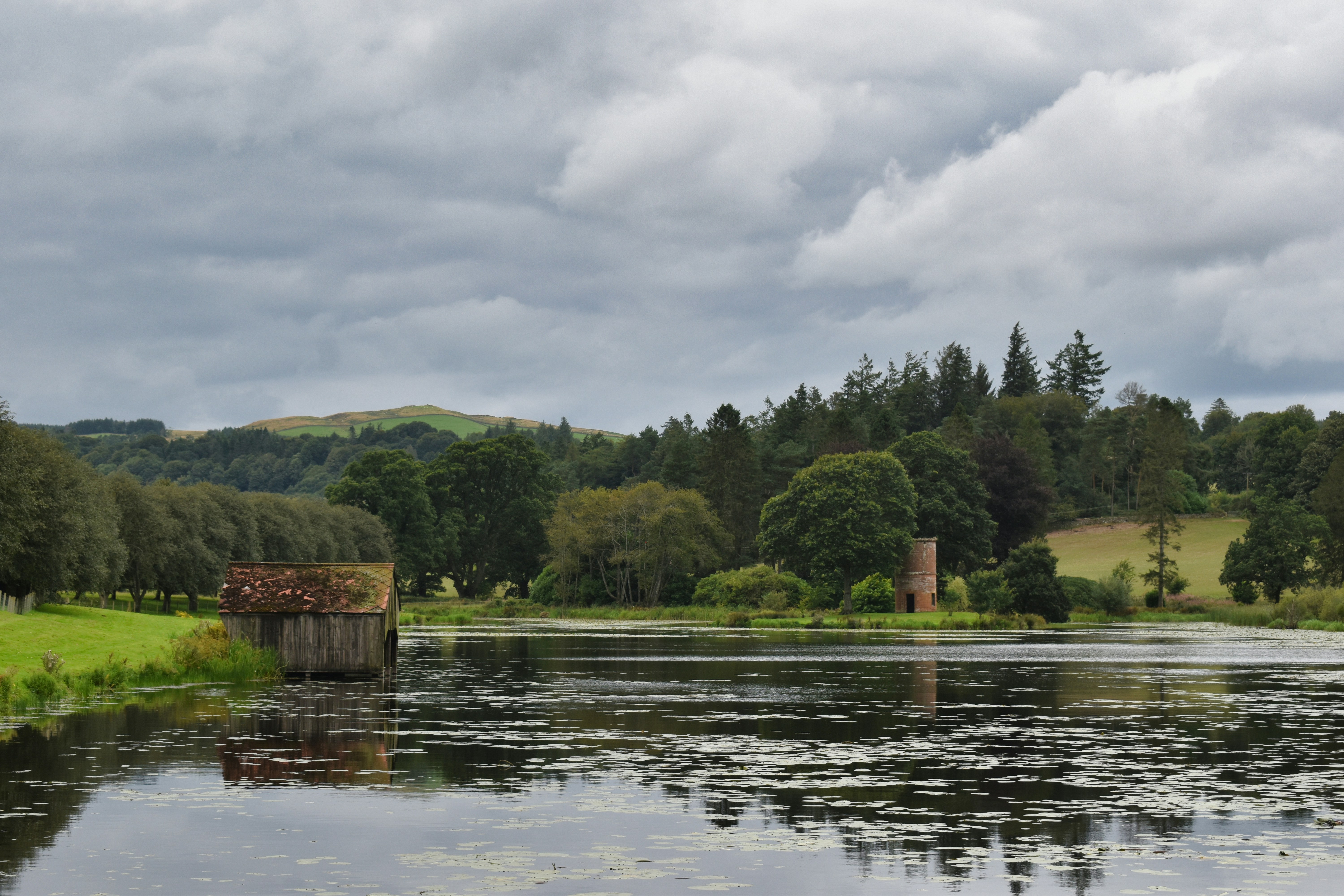 Weathered Boathouse at the Lake's Edge Under Quiet Skies
