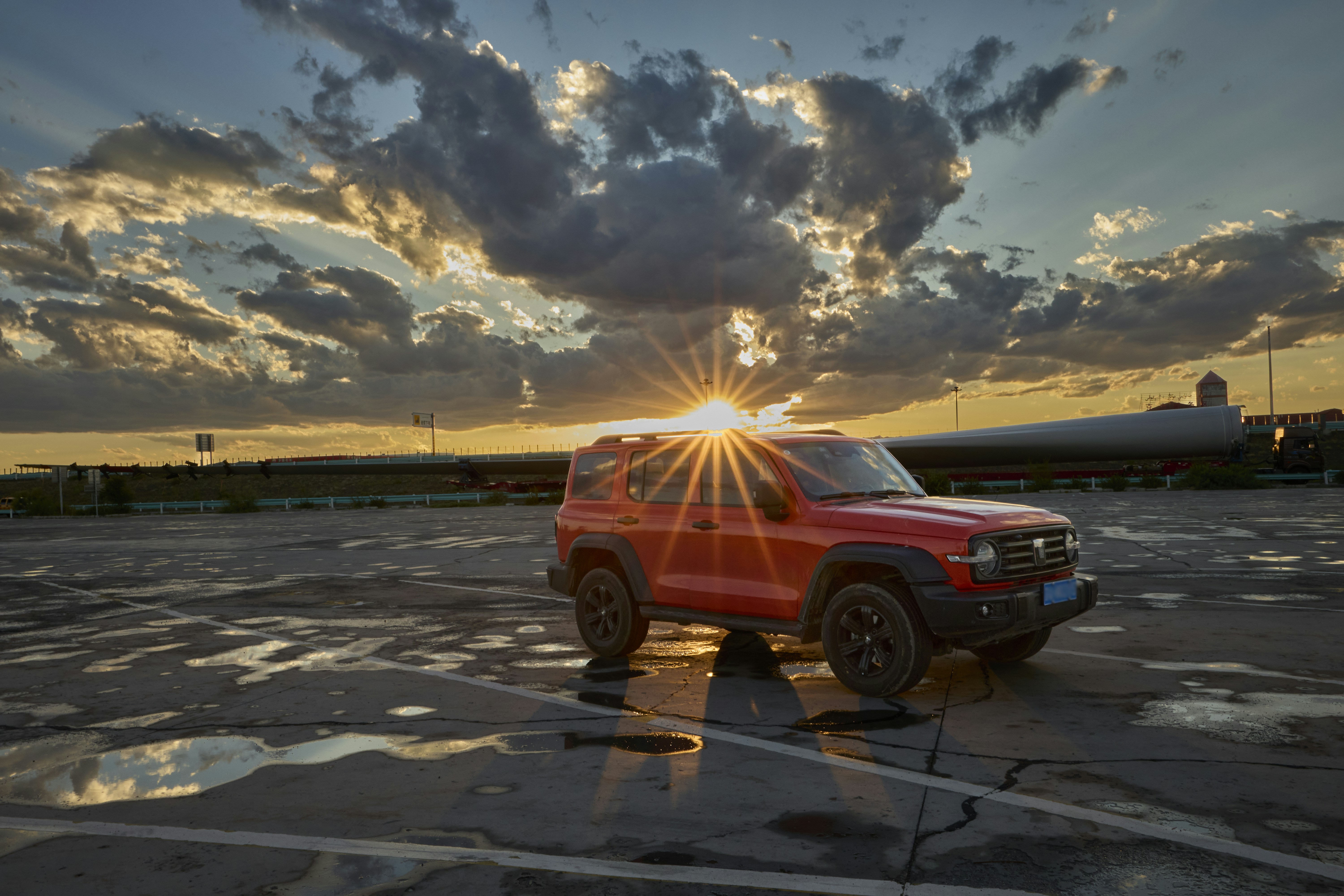 Sunburst Over Red SUV: a Rain-Washed Runway at Dusk
