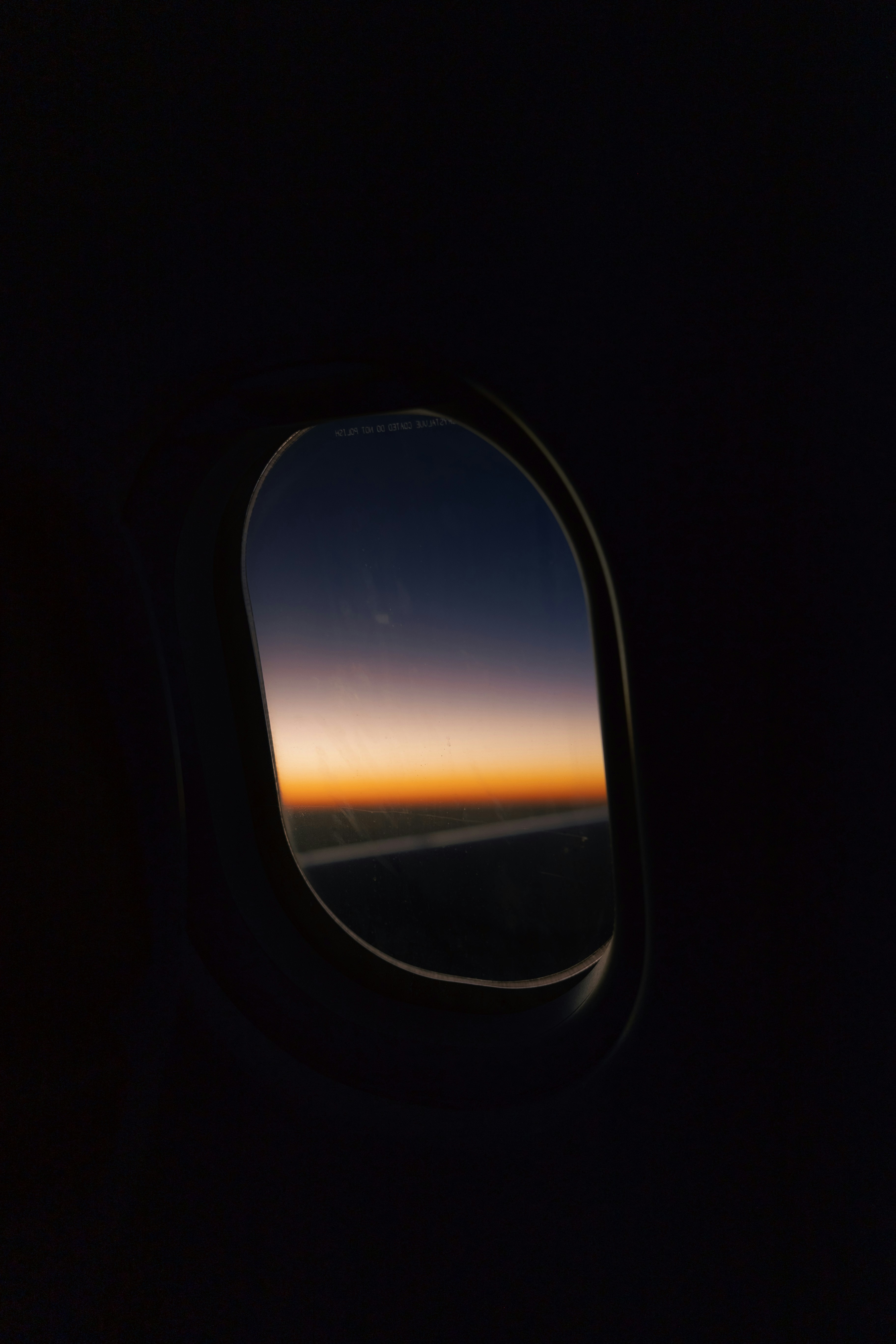The view out of an airplane window at sunset
