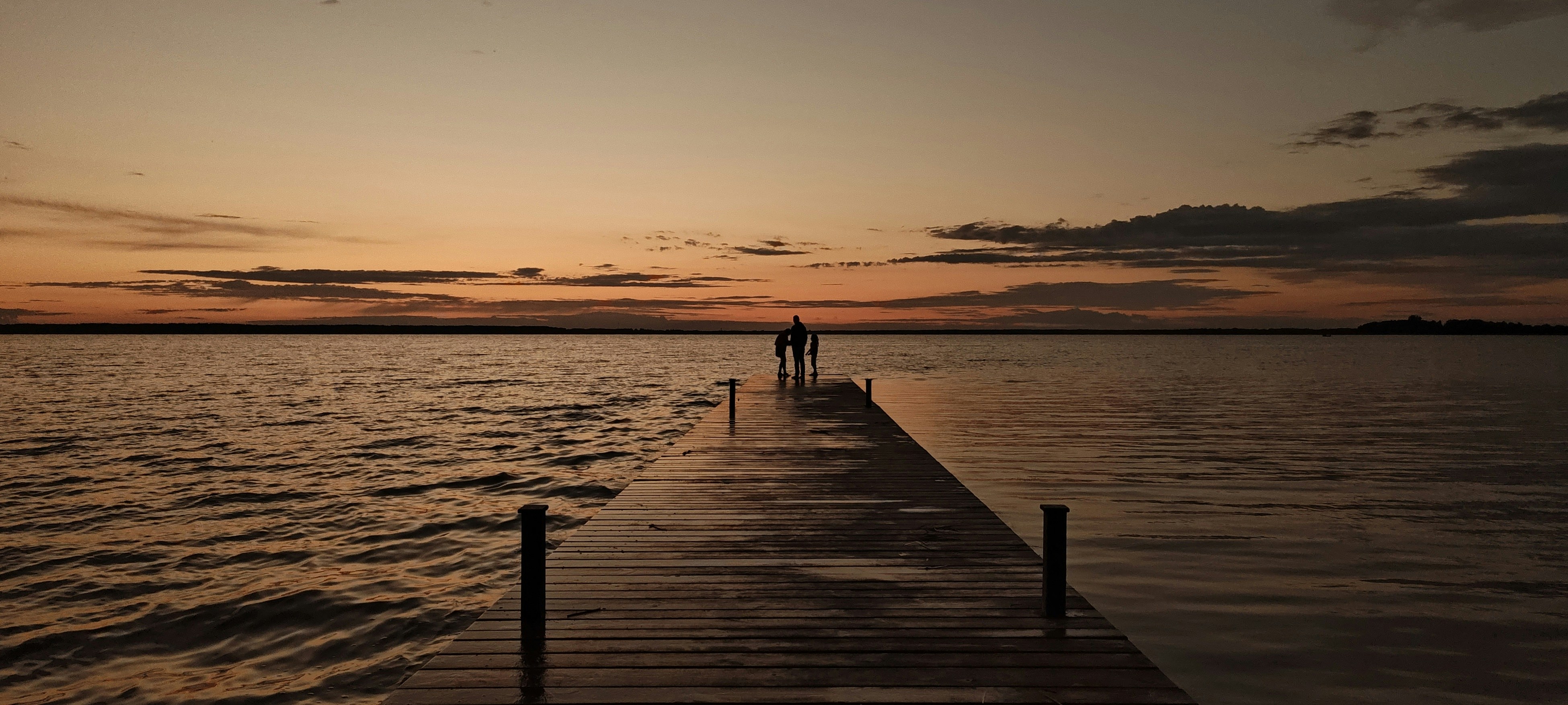 A long dock with a sunset in the background photo – Free Ukraine Image ...
