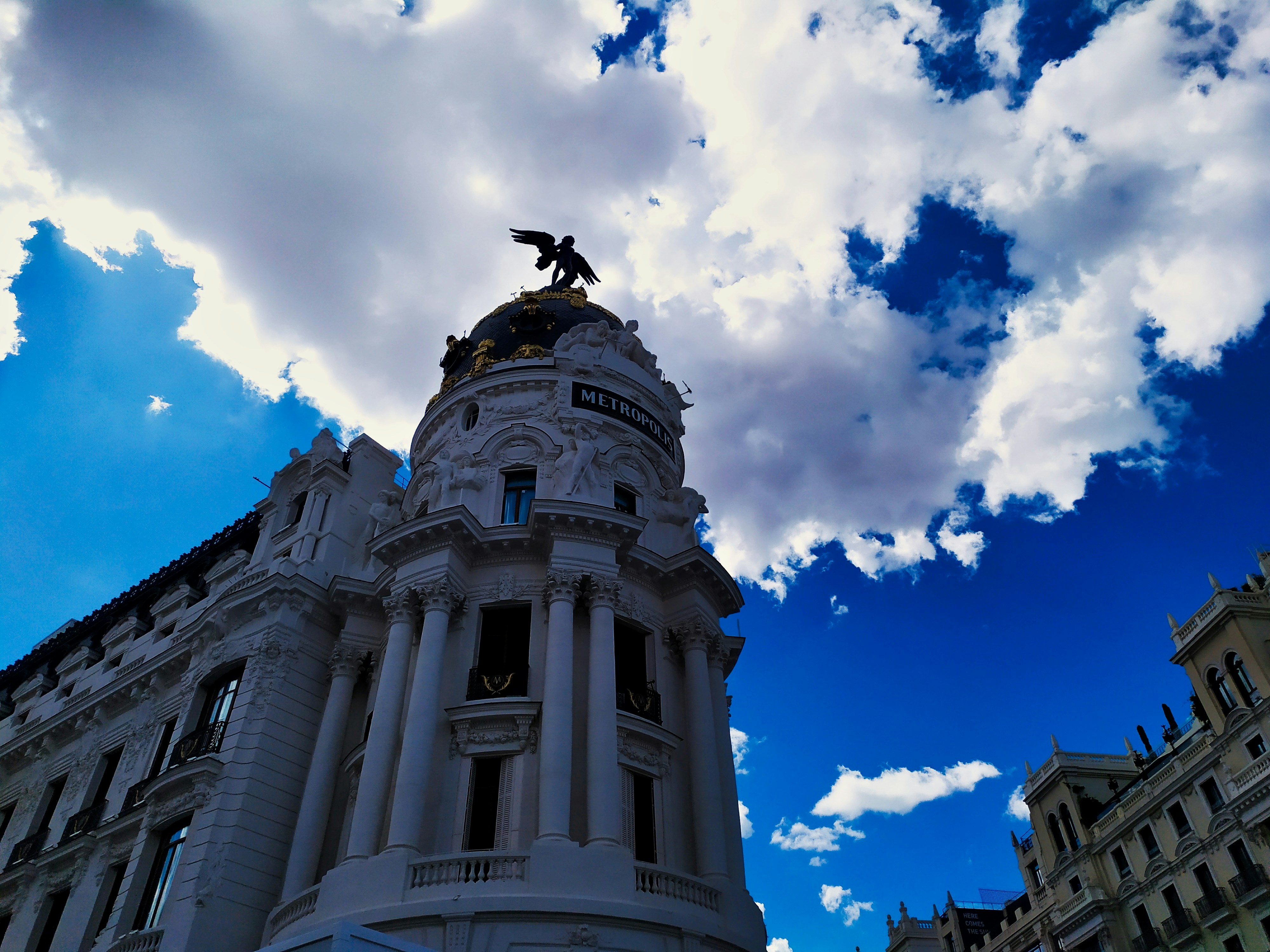 Winged Victory Above Madrid's Metropolis: Sky, Stone, and Shadow