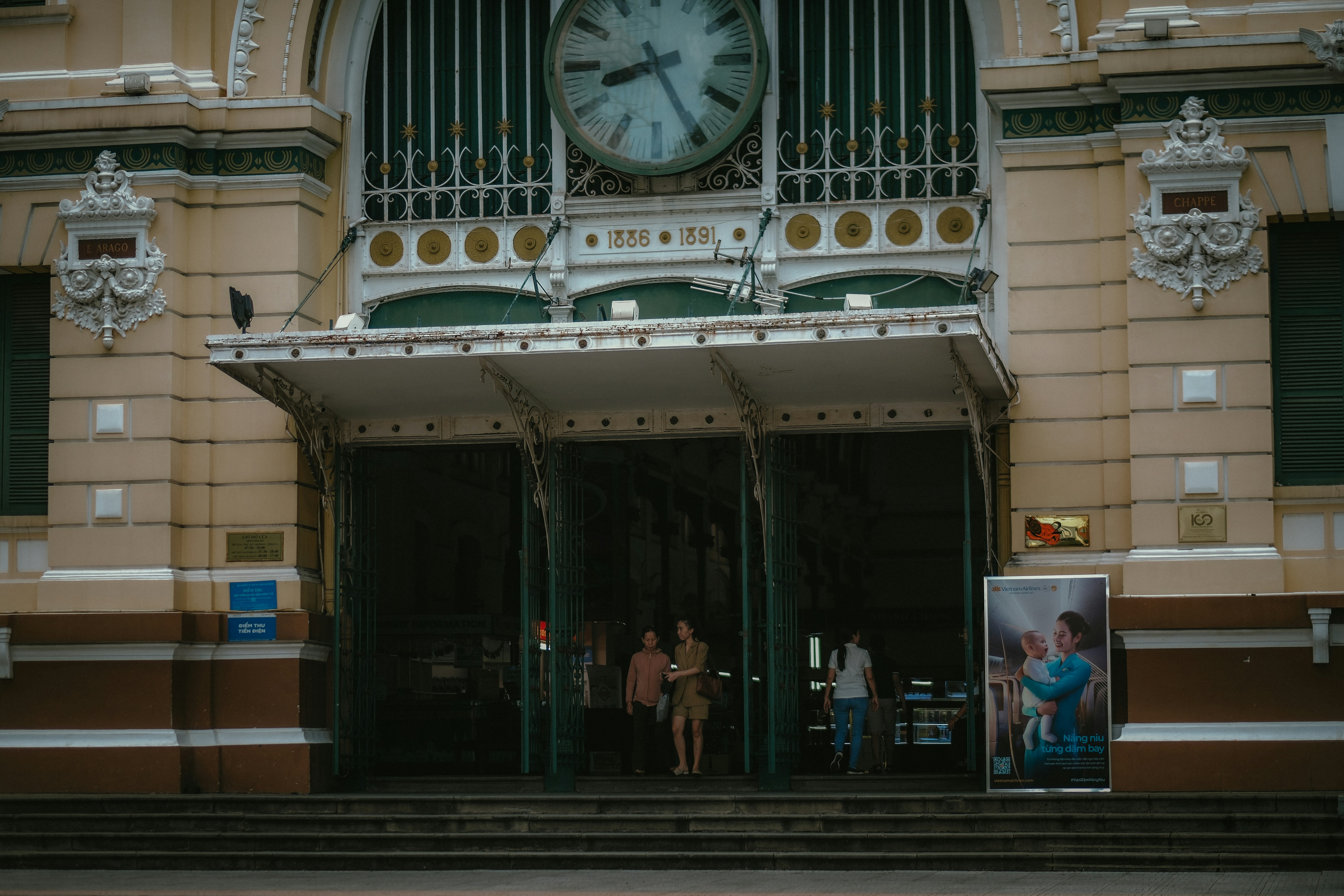 Timekeeper's Arch: Pedestrians at a Historic Station Entrance Under a Grand Clock