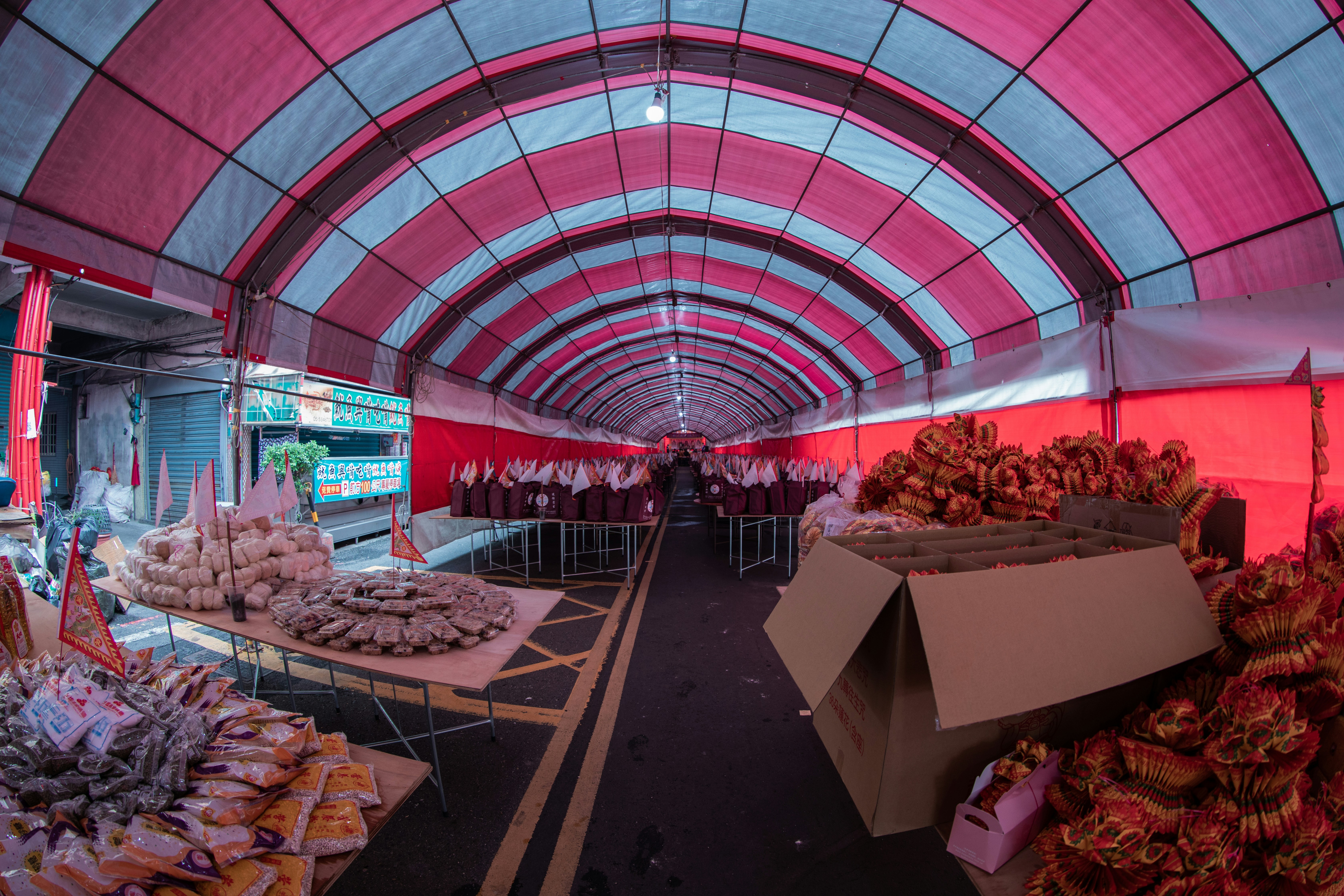 Red-Blue Canopy Market: A Wide-Angle Walk Through Stacked Produce