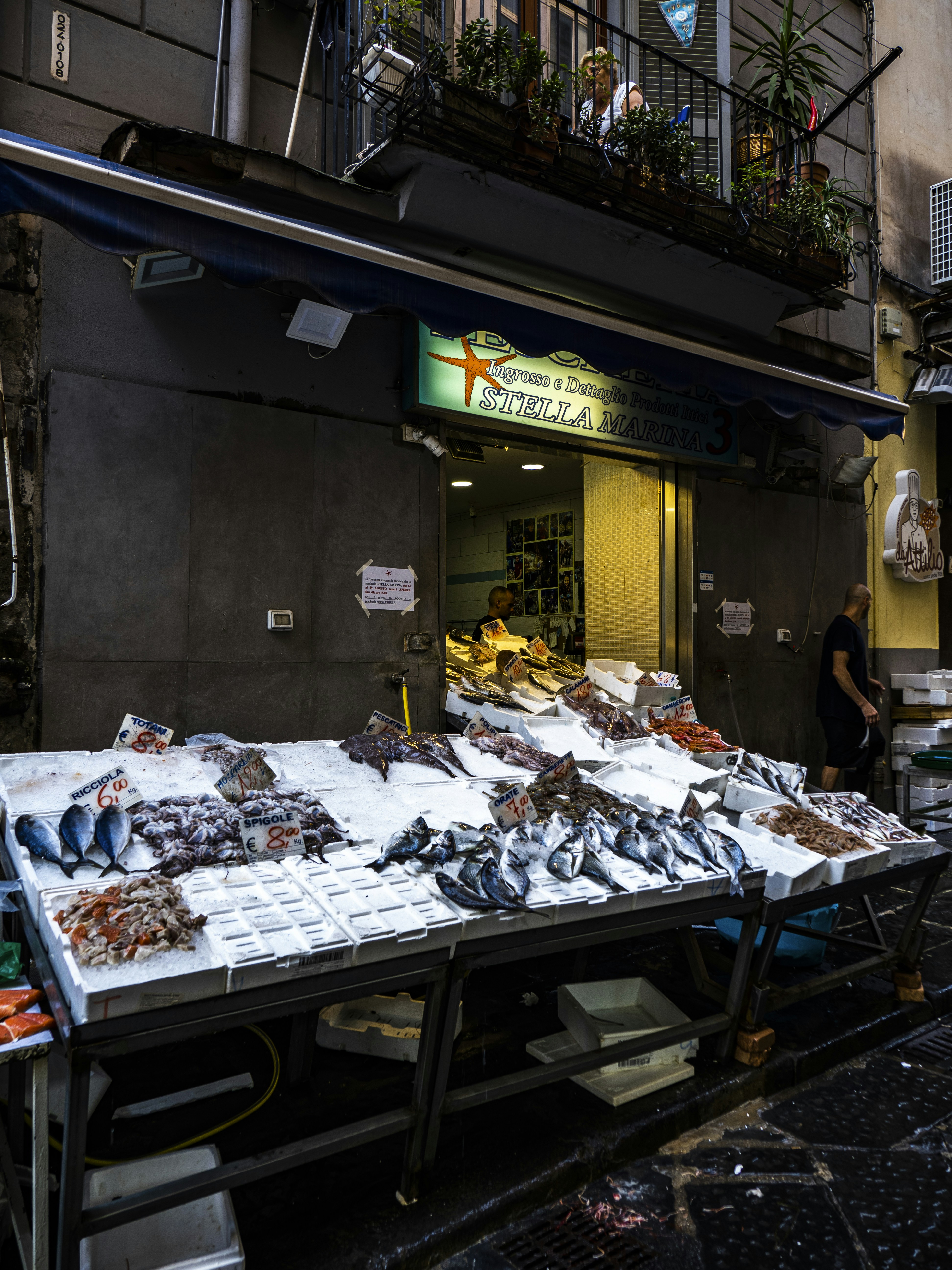 Silver Scales on a Streetfront: A Bustling Fish Stall Spills Across the Sidewalk