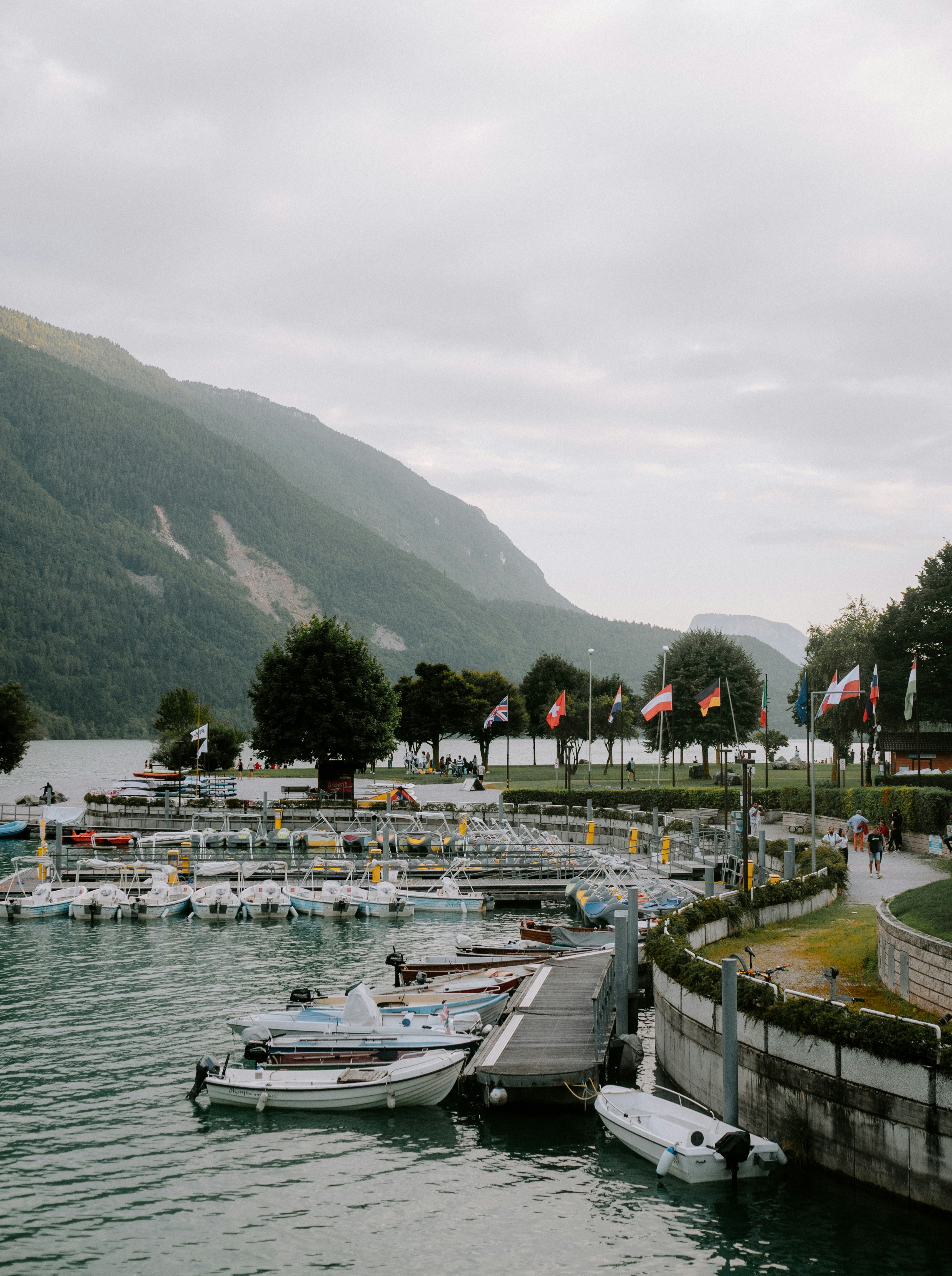 Dockside Mosaic: Boats, Flags, and Mountain Light