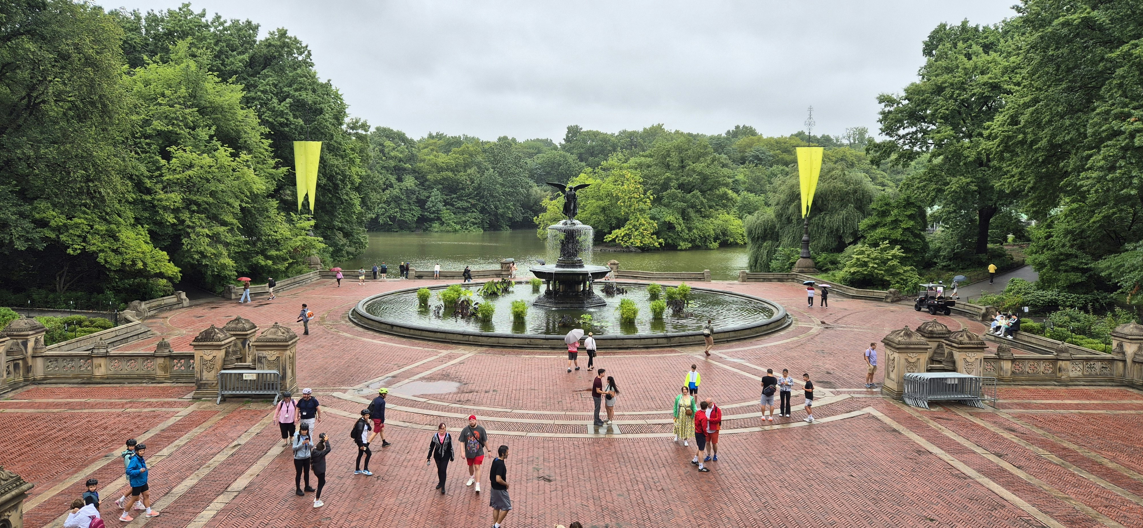 Reflections and Rings: People Gather at a Two-Tiered Fountain Plaza