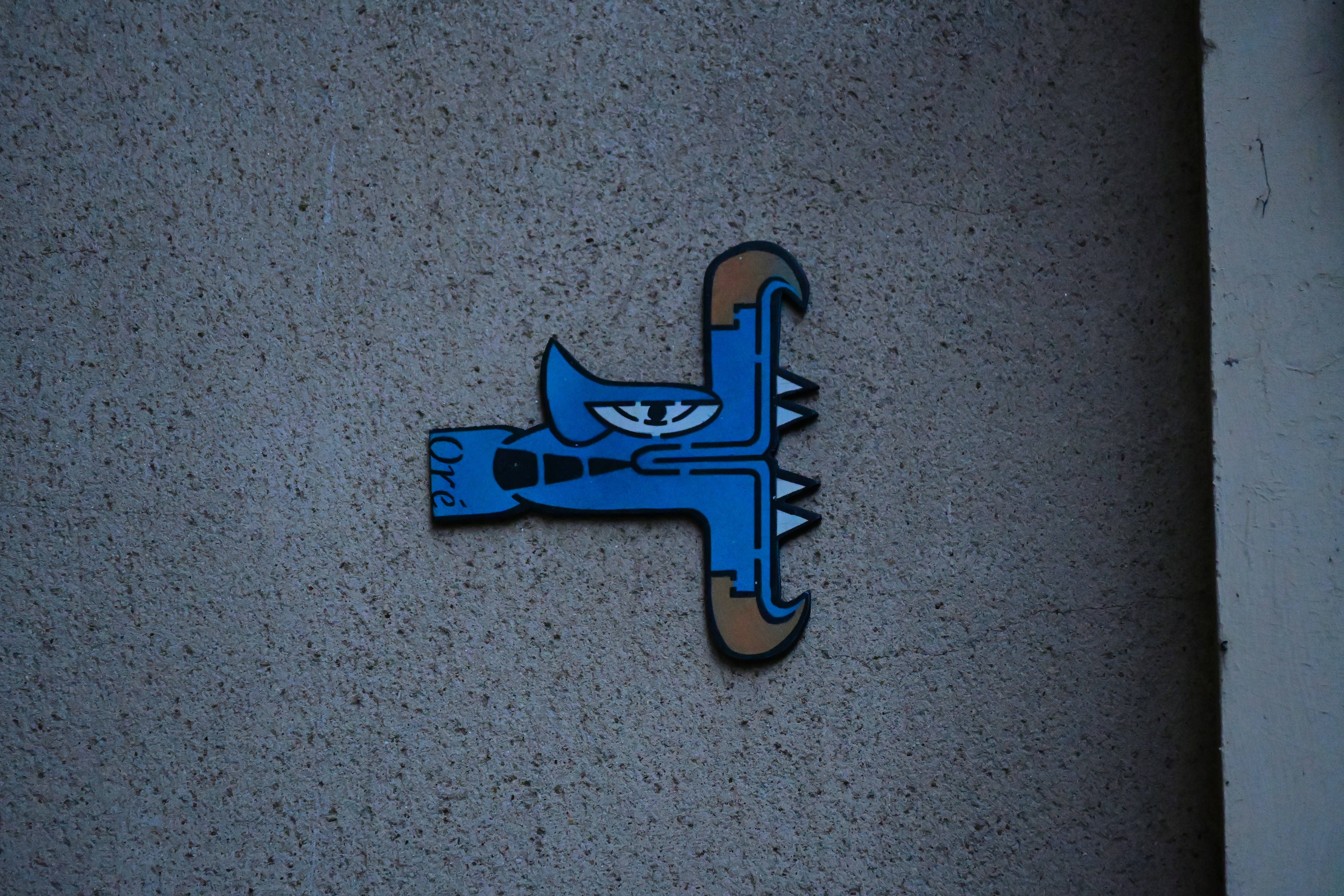 Colorful cartoon airplane illustration affixed to a textured wall, showcasing playful design elements.