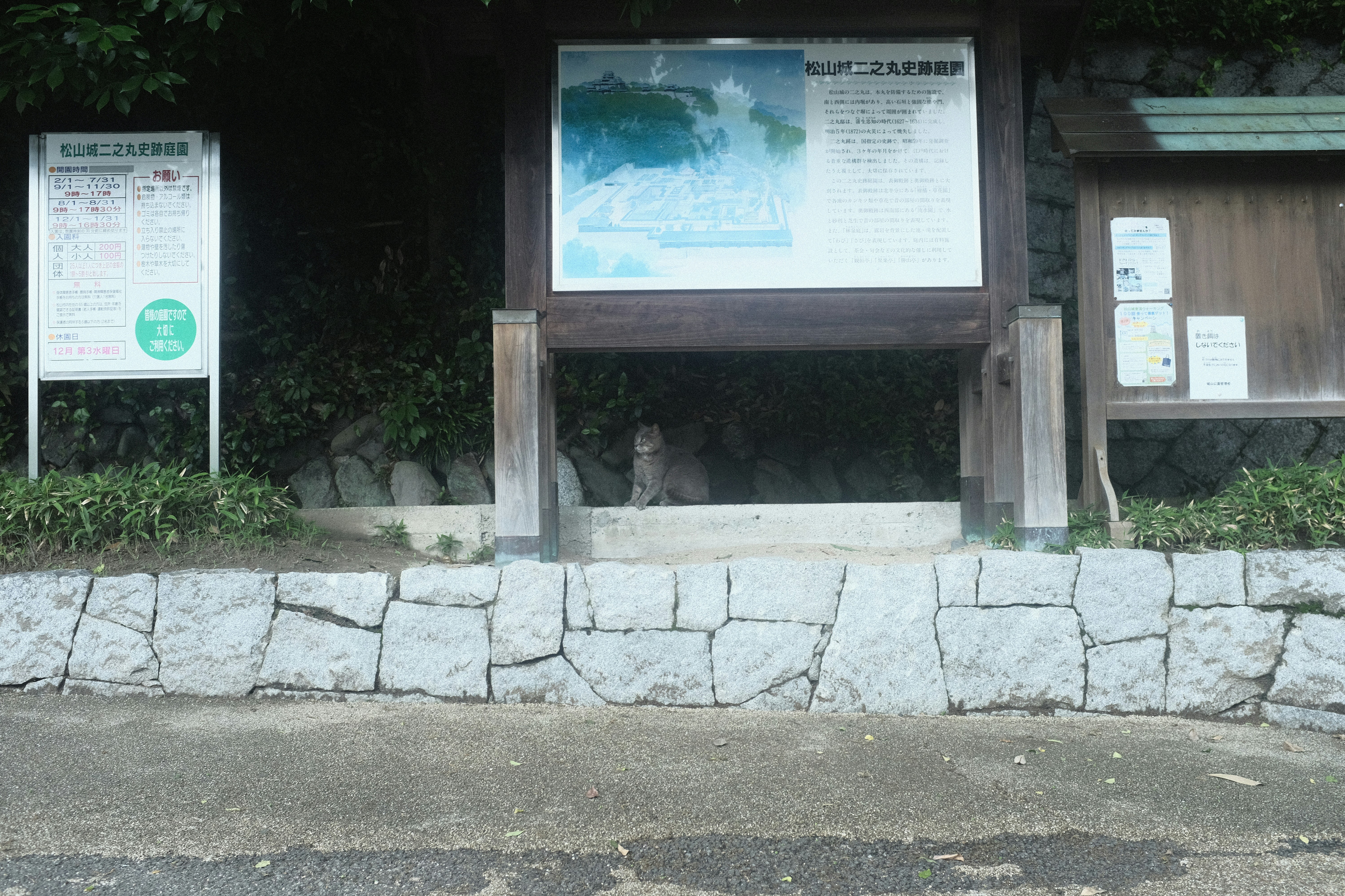 Trailhead Map Under a Timber Frame, Surrounded by Stone and Greenery