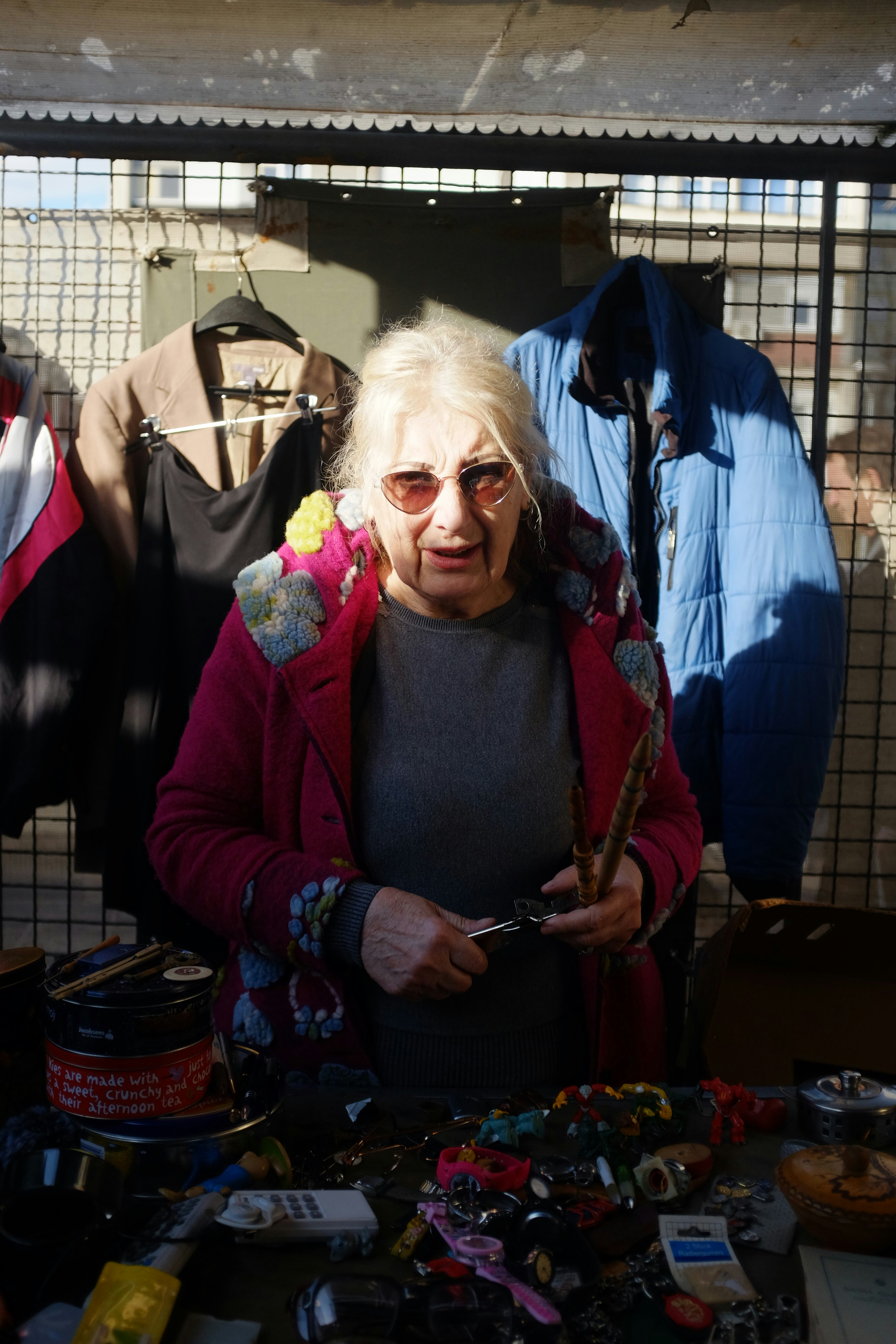 A woman standing in front of a table full of items photo – Free Travel ...