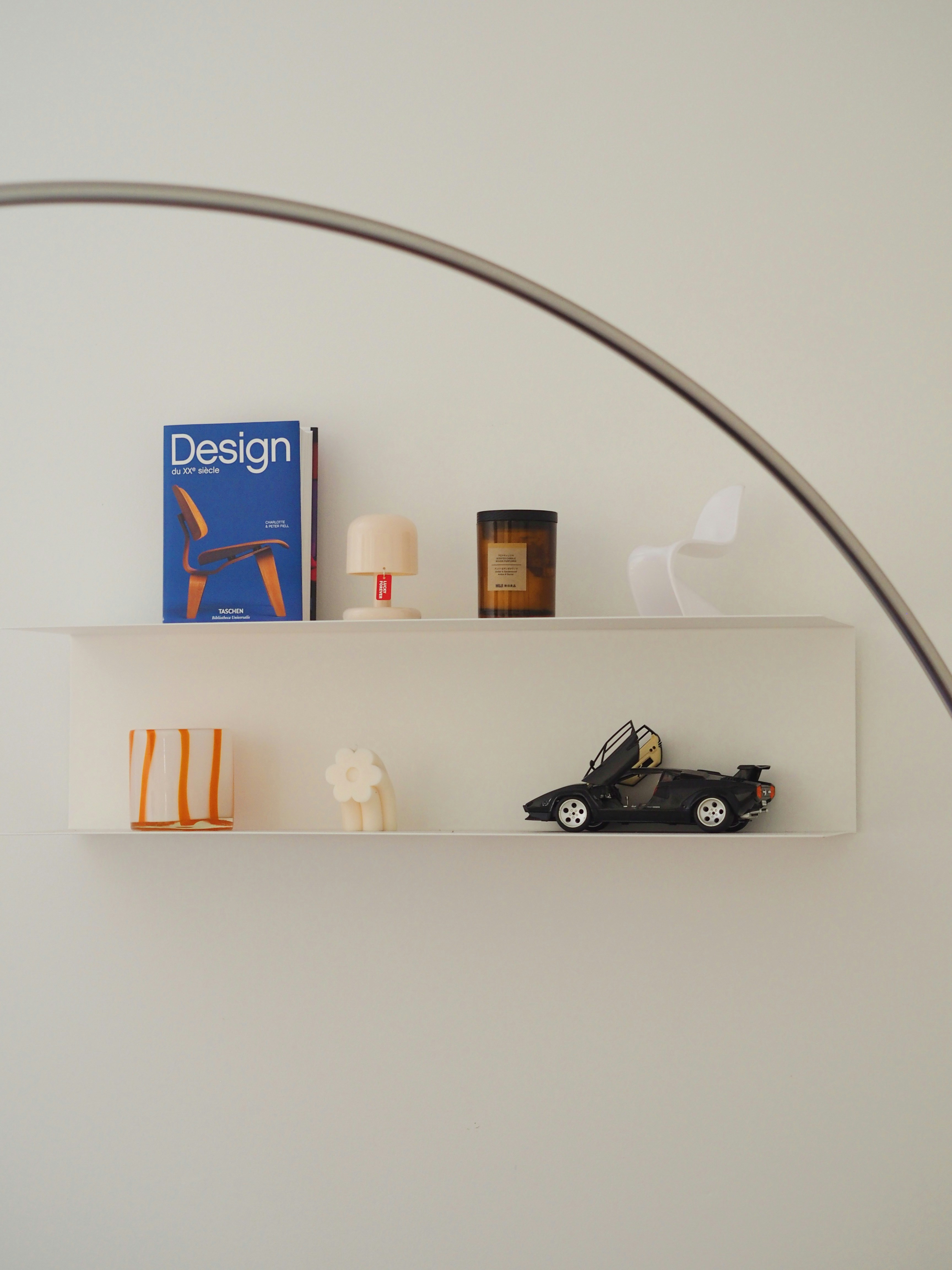 Shelf of design curios: a quiet still life in white
