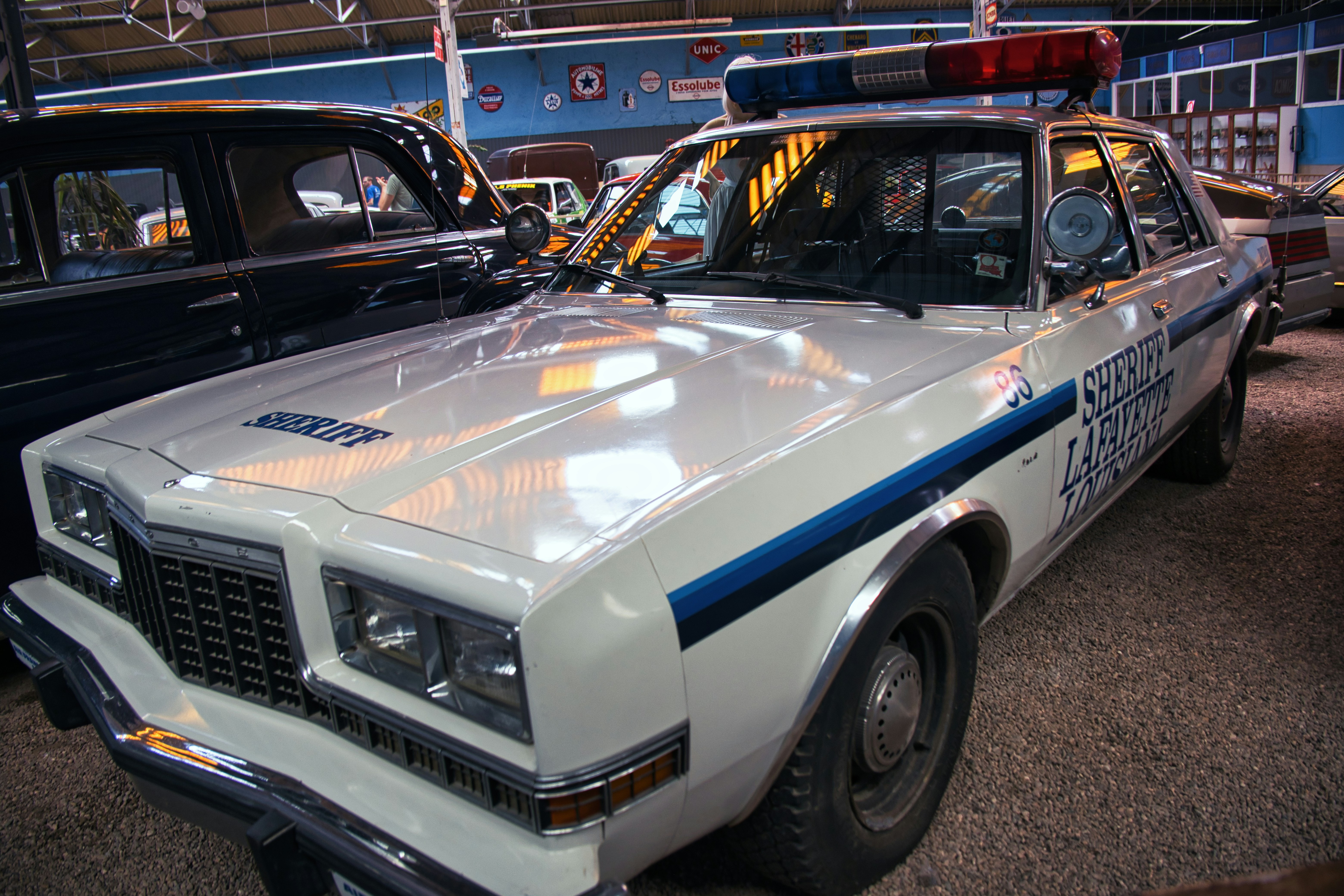 Chrome and Blue: A Vintage Sheriff Patrol Car in a Quiet Showroom