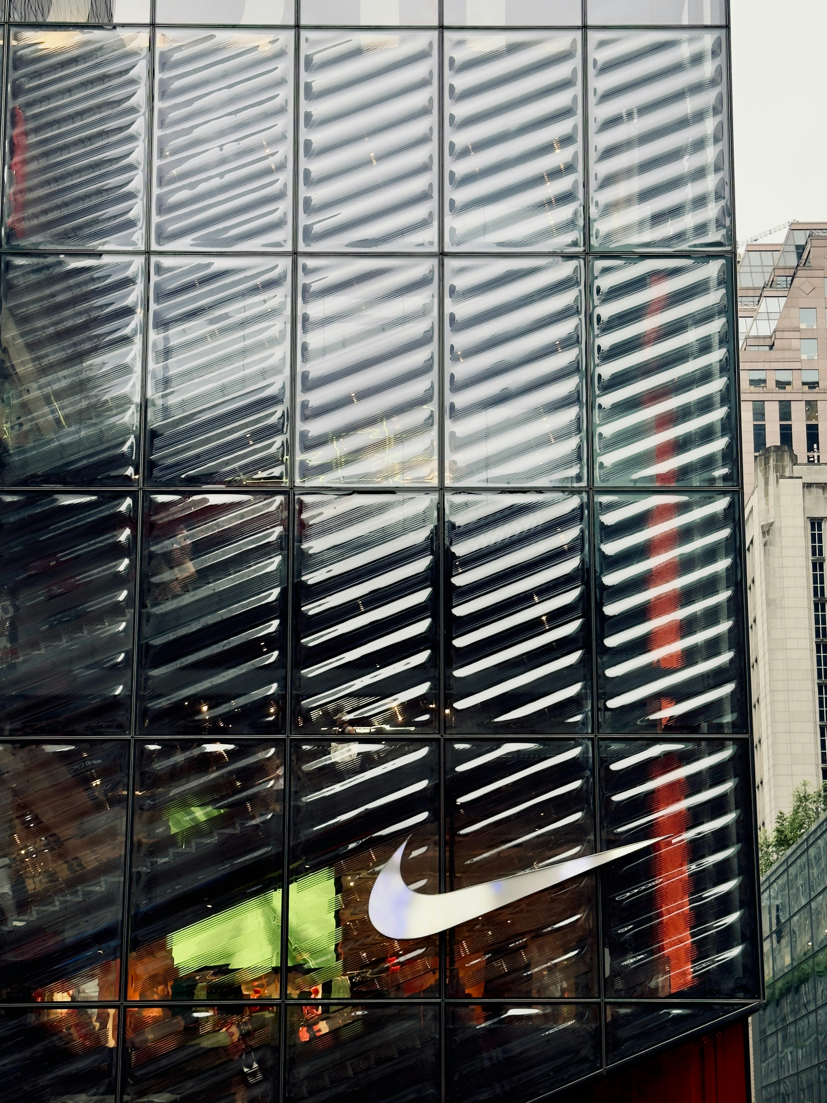 Diagonal Glass Mosaic Encasing a Nike Swoosh in Urban Light