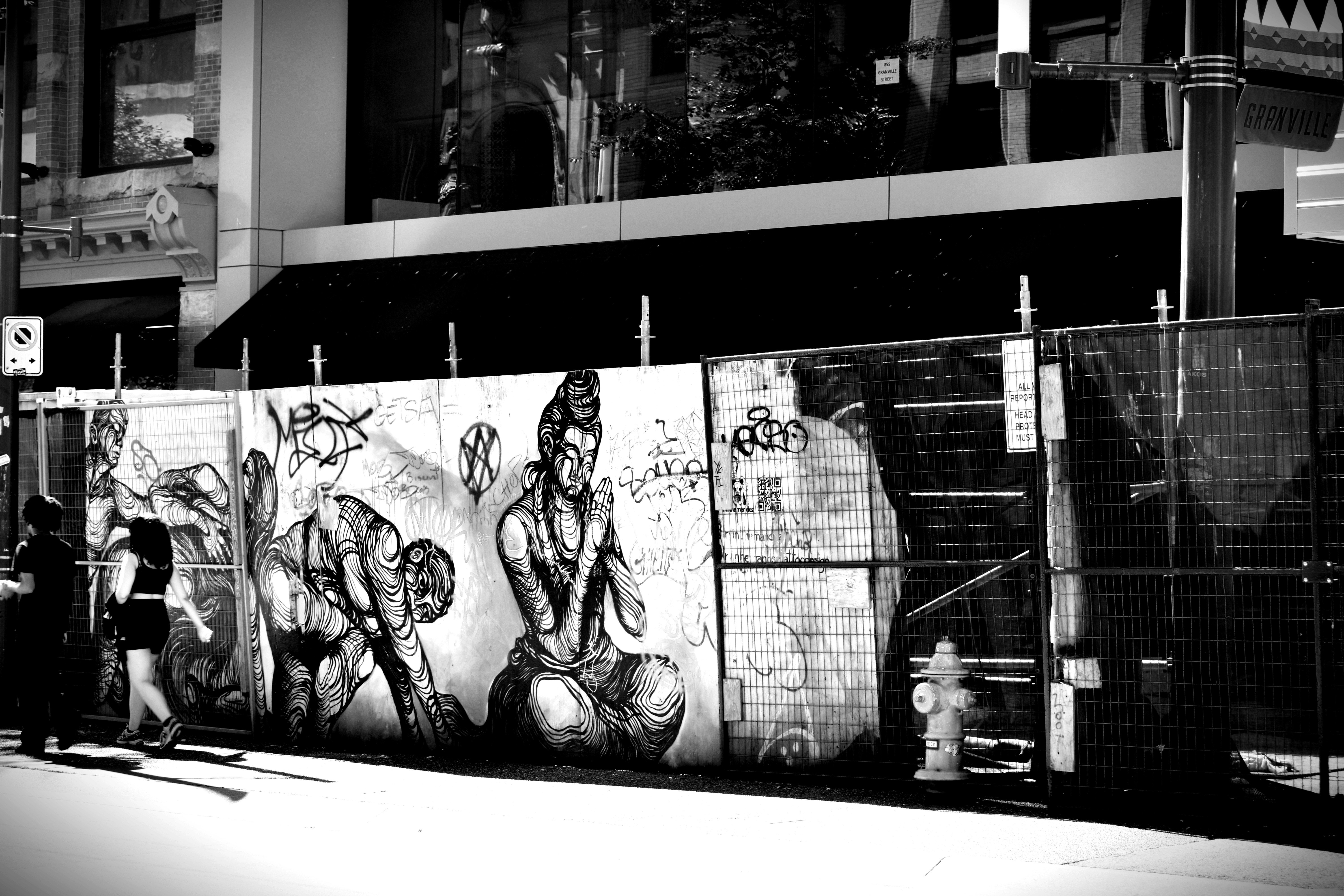 Urban Graffiti Wall: A Quiet Moment by the Fence
