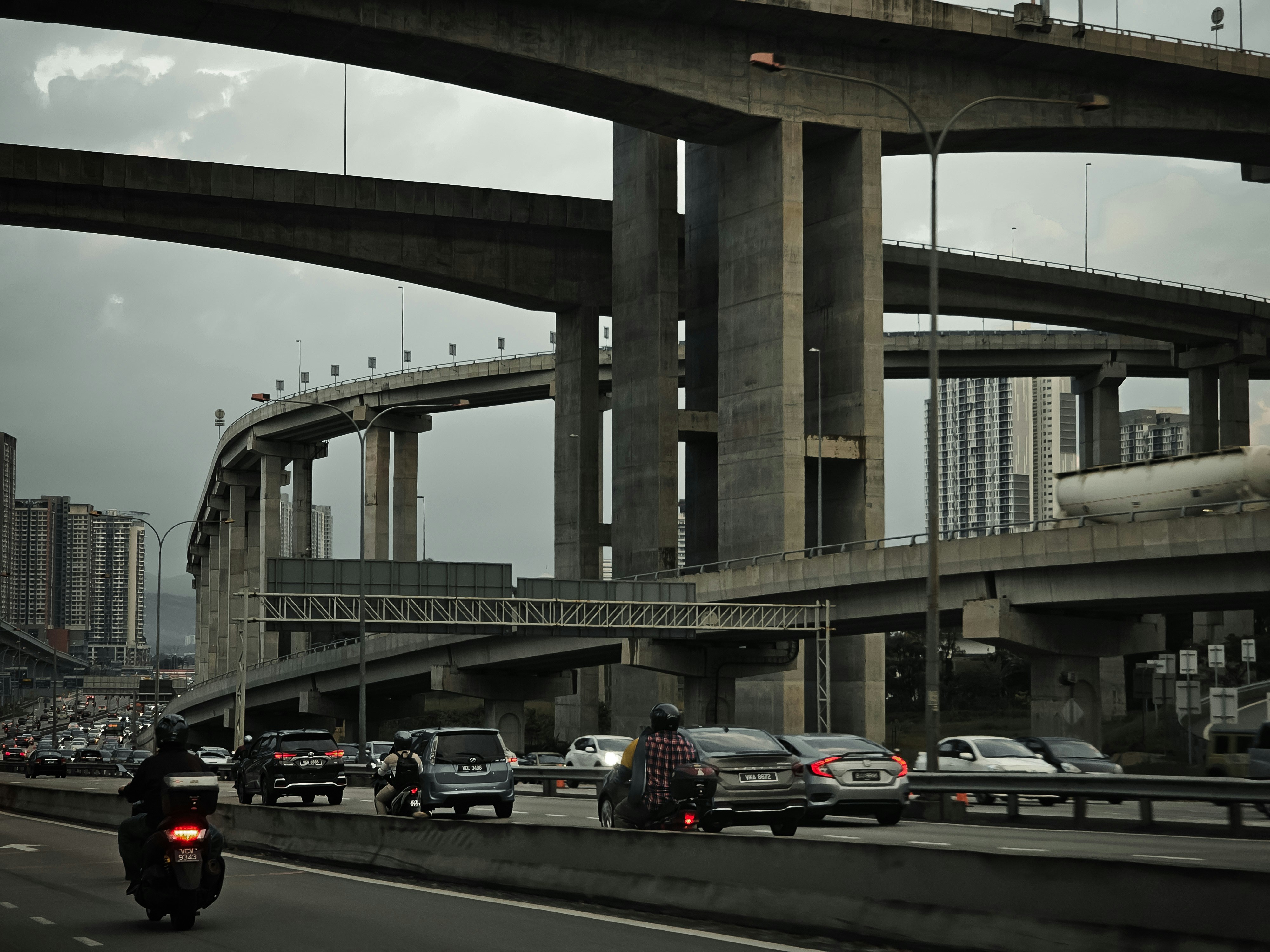 A highway filled with lots of traffic next to tall buildings photo ...