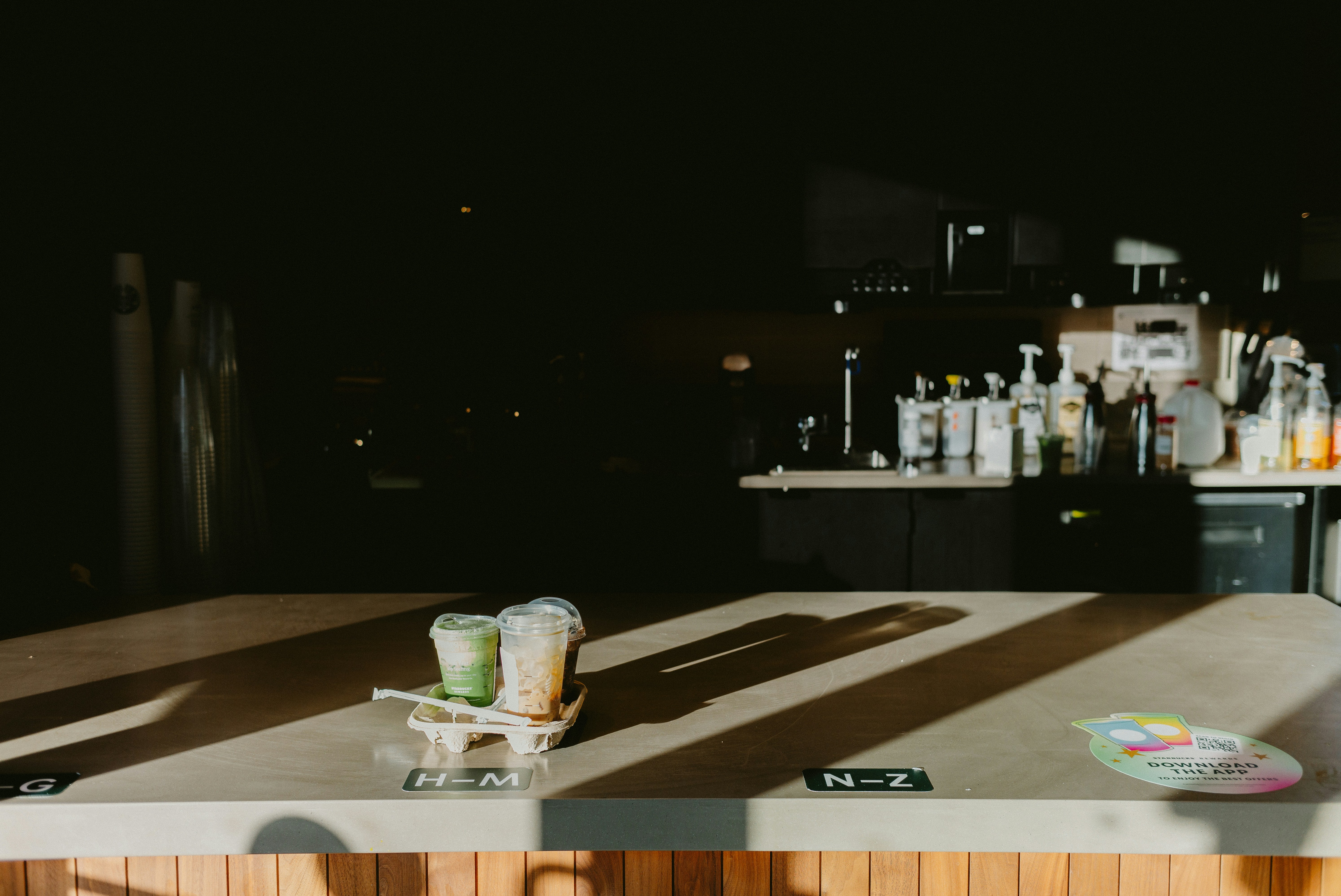 Two Mugs in a Diagonal Sunbeam on a Bar Counter