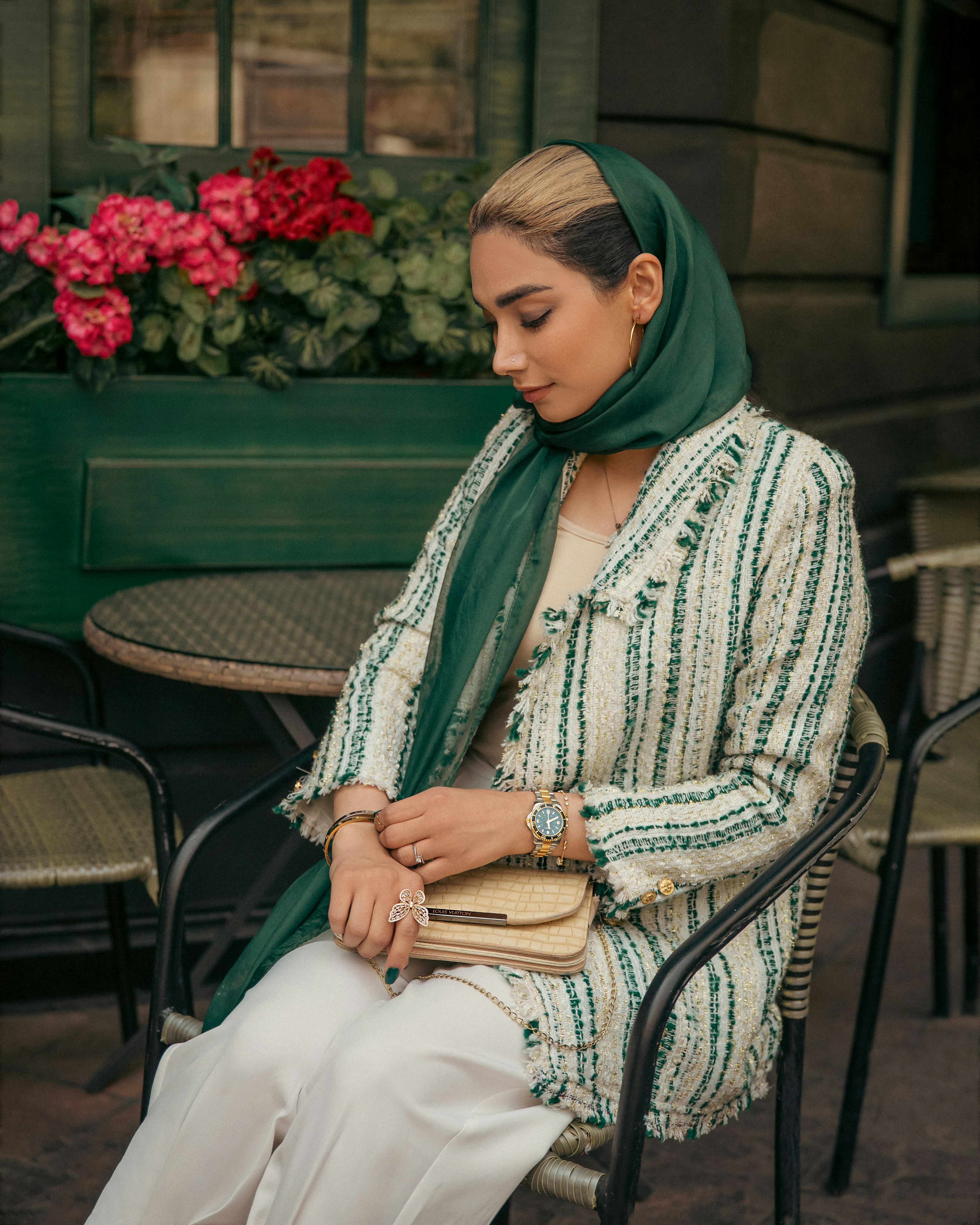 Elegance in Green: A Quiet Moment on the Café Terrace