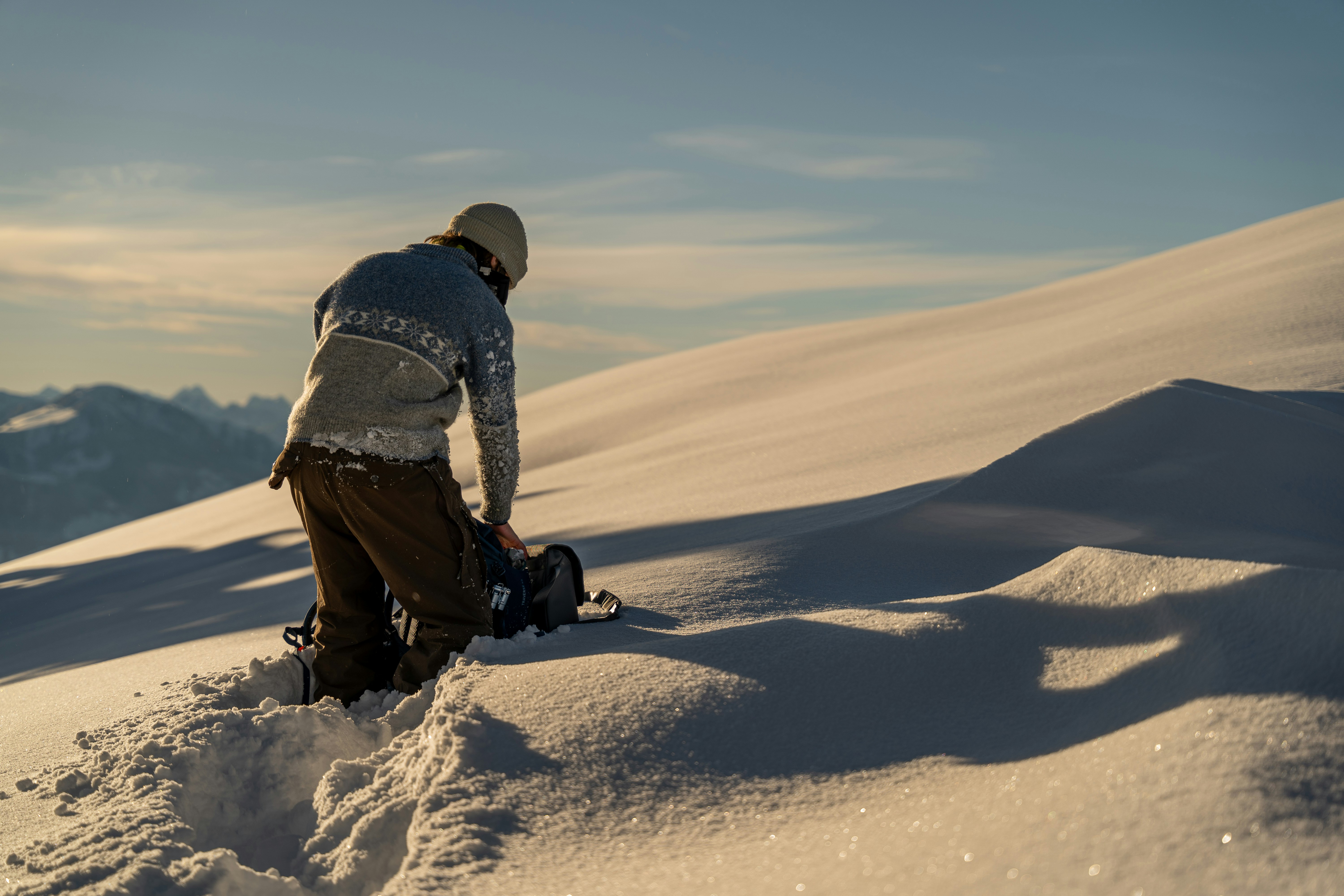 Snowbound Ascent: A Surfer Climber Quietly Shapes a Wake on the Dune