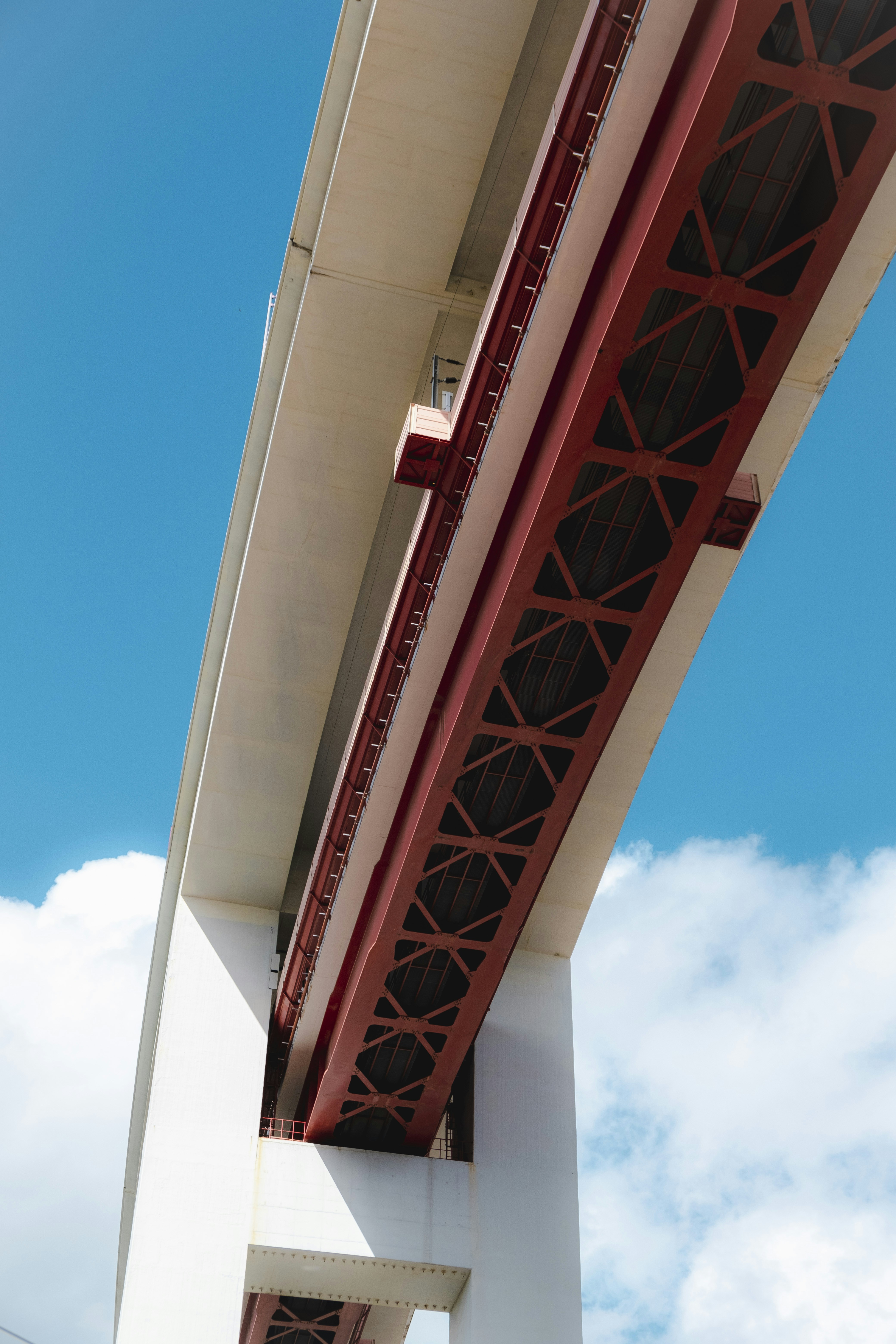 Crimson Truss Against Sky: A Diagonal Bridge Study