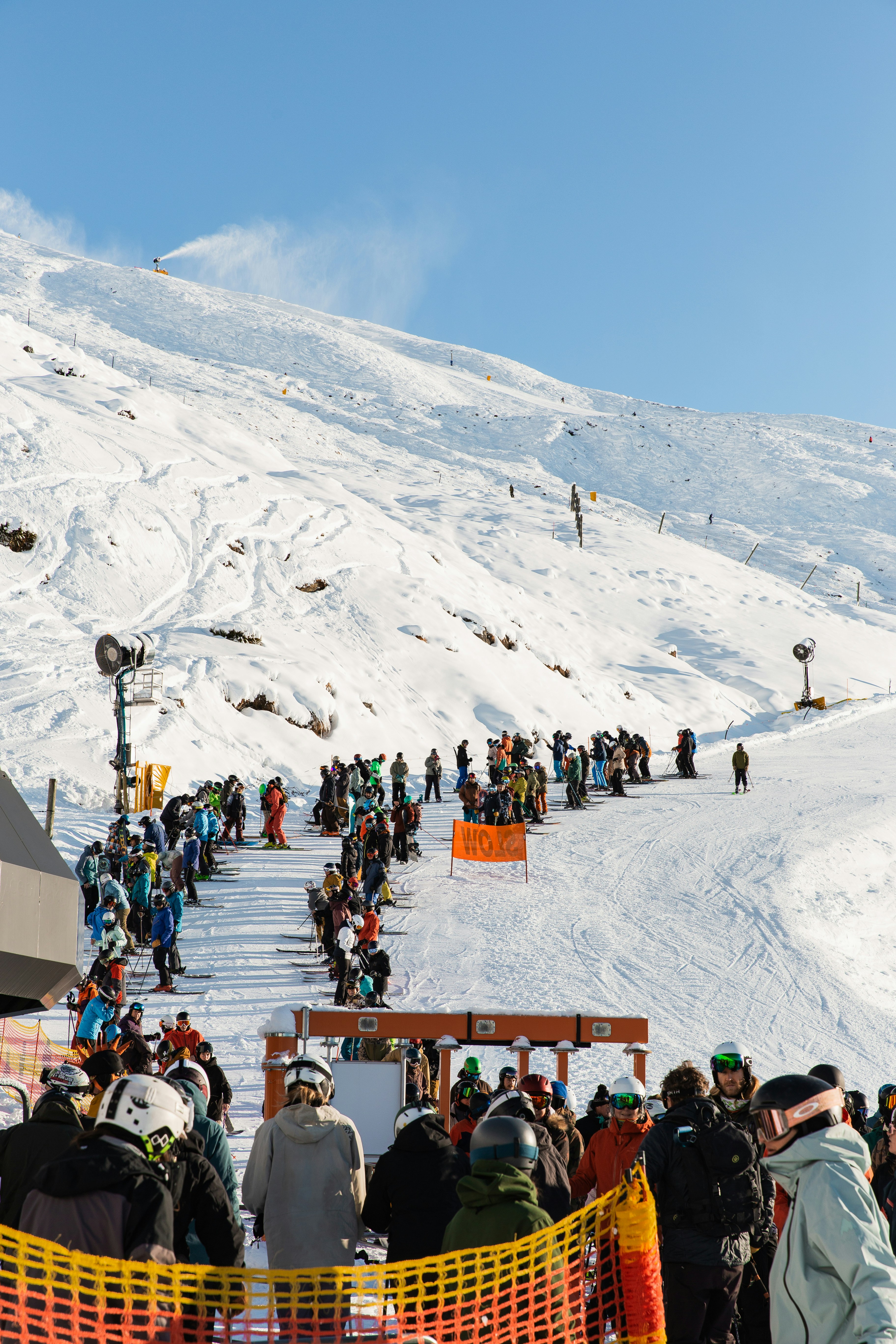 A crowd of people standing on top of a snow covered slope photo – Free ...