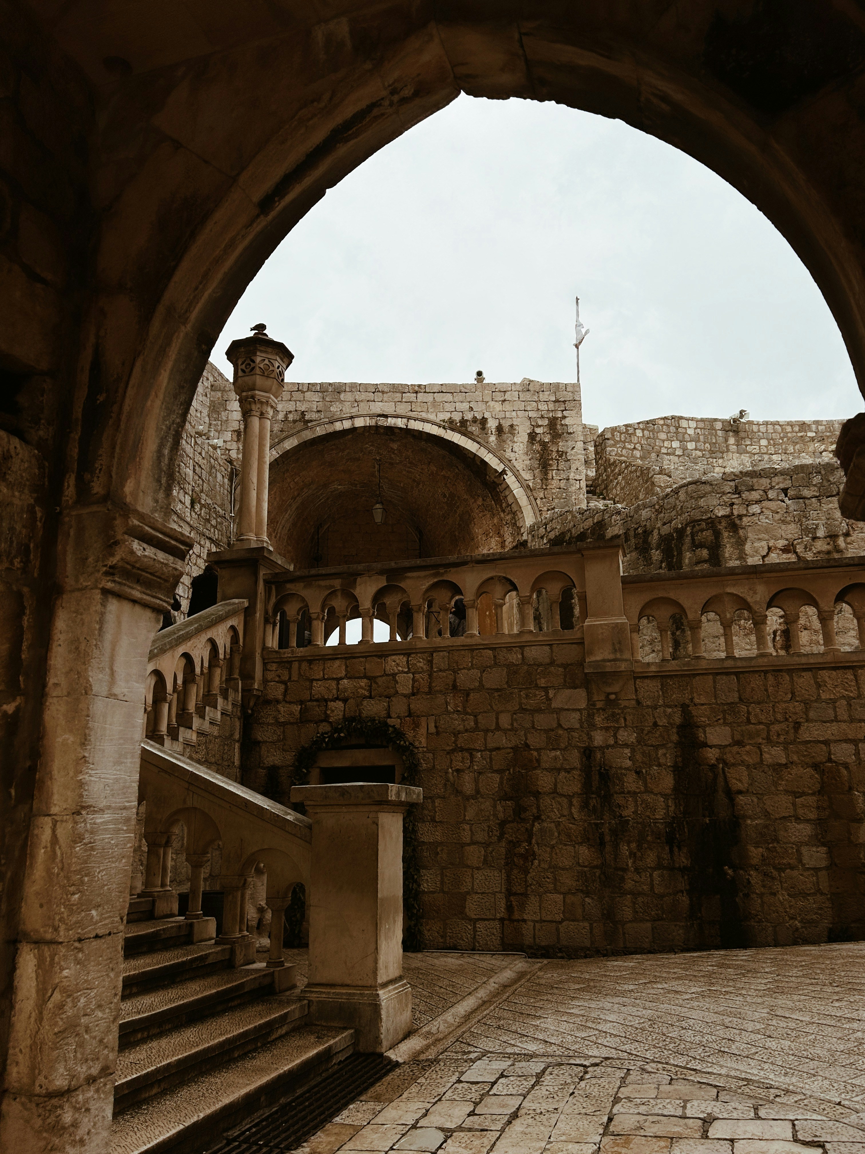 A large stone building with a staircase leading up to it photo – Free ...