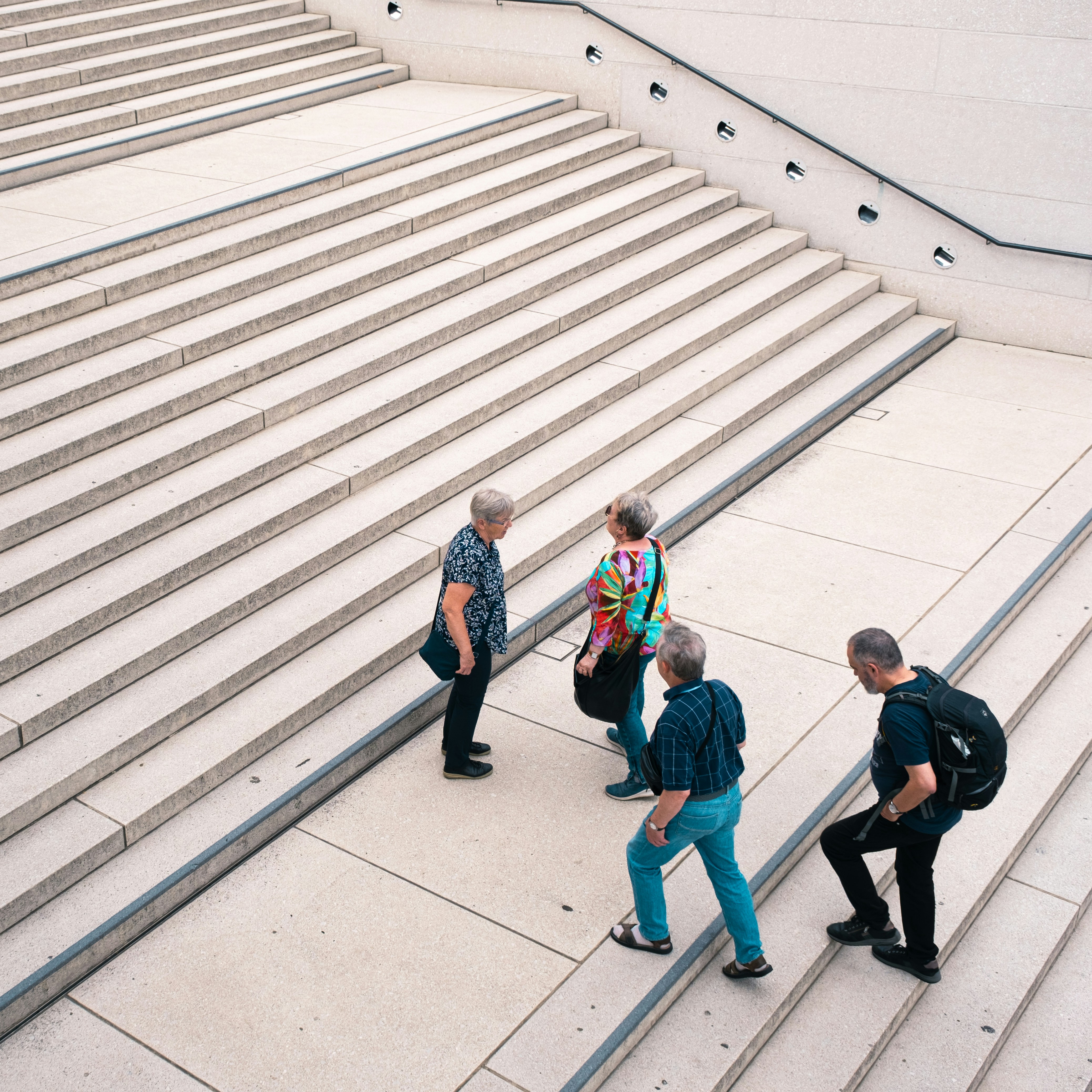 A group of people walking up and down some steps photo – Free Minimal ...