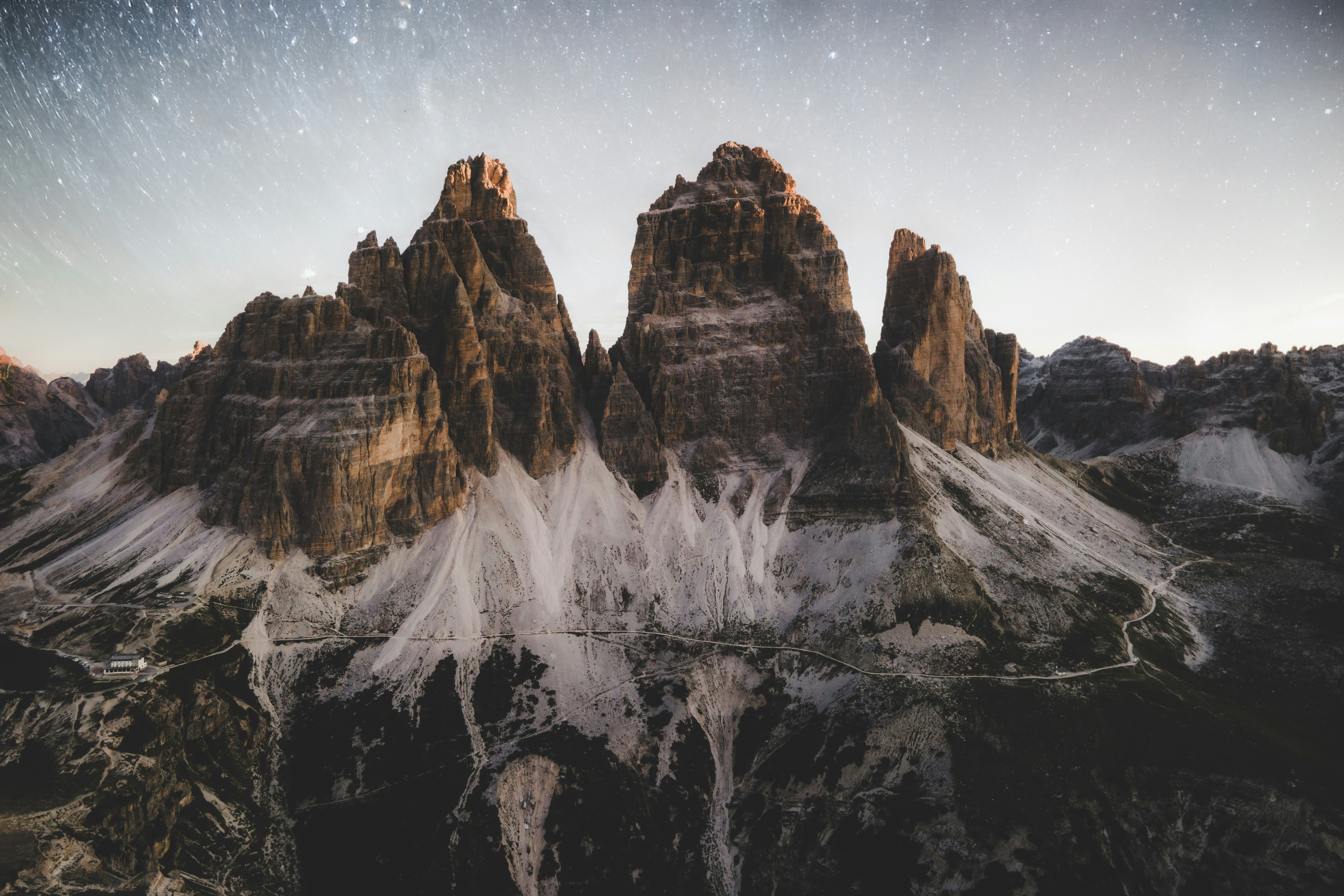 A group of mountains with stars in the sky photo – Free Scenery Image ...