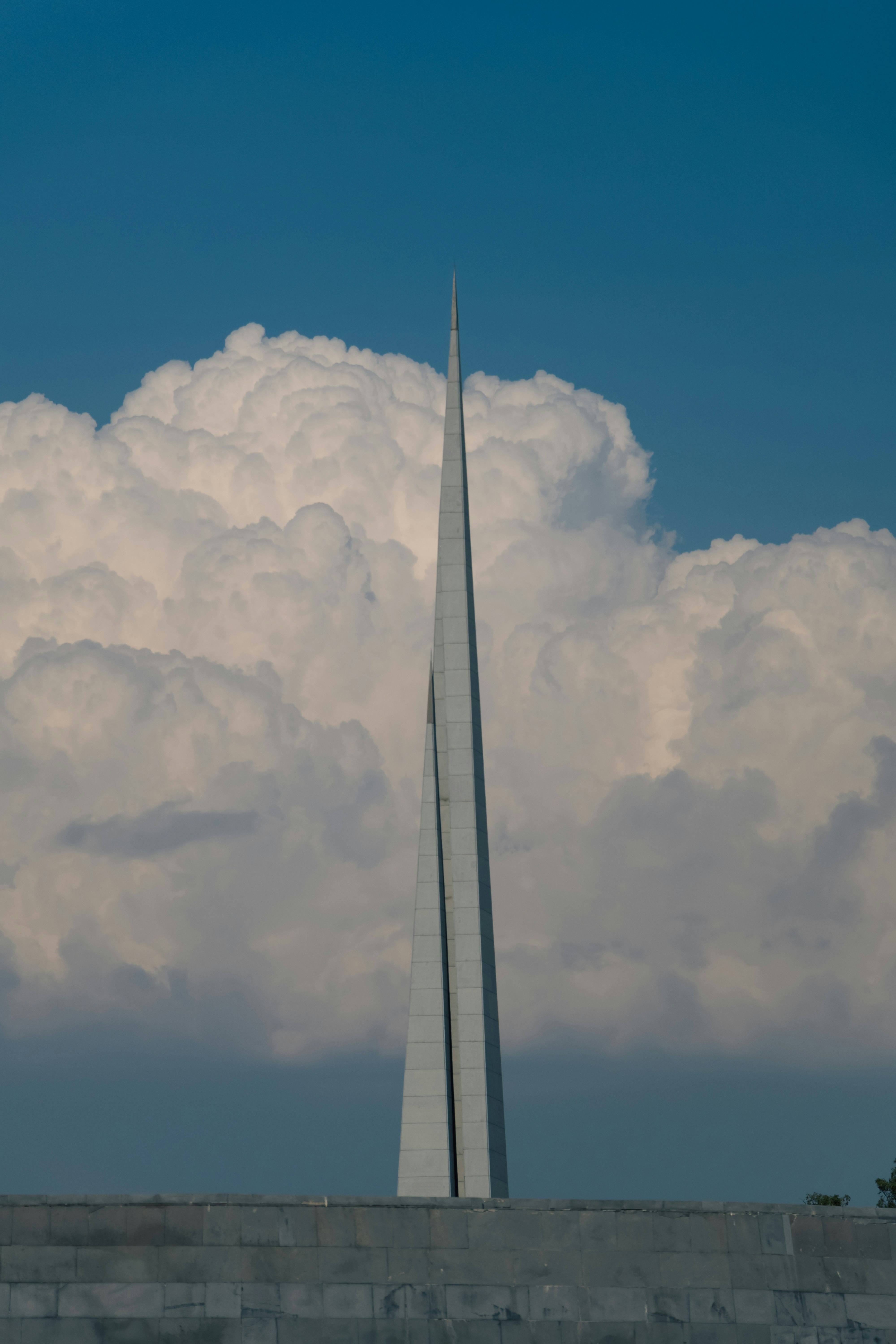 Vertical Needle Rising Through a Sea of Clouds